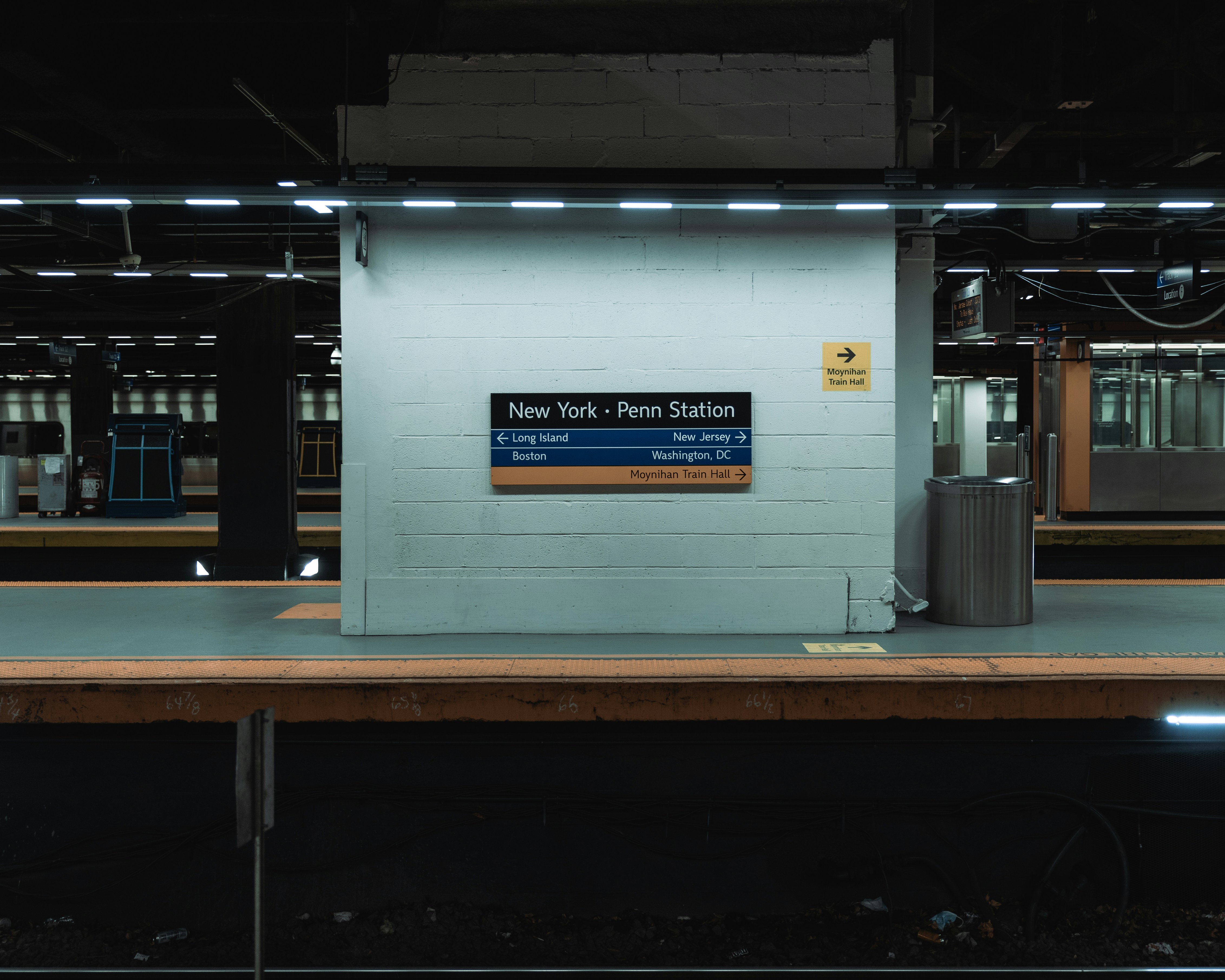 A train station with a sign on the side of it photo – Free Train Image ...