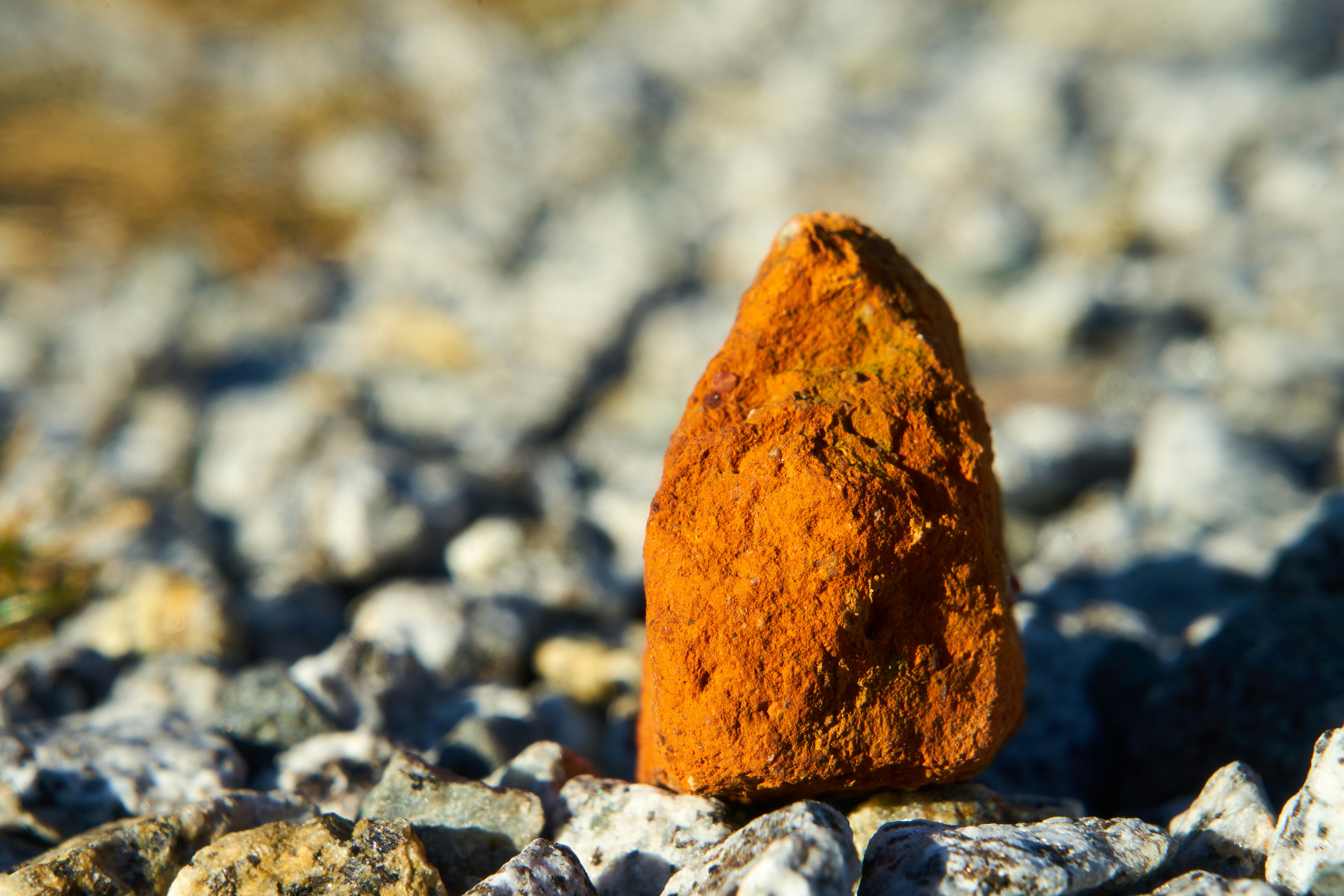 a rock sitting on top of a pile of rocks