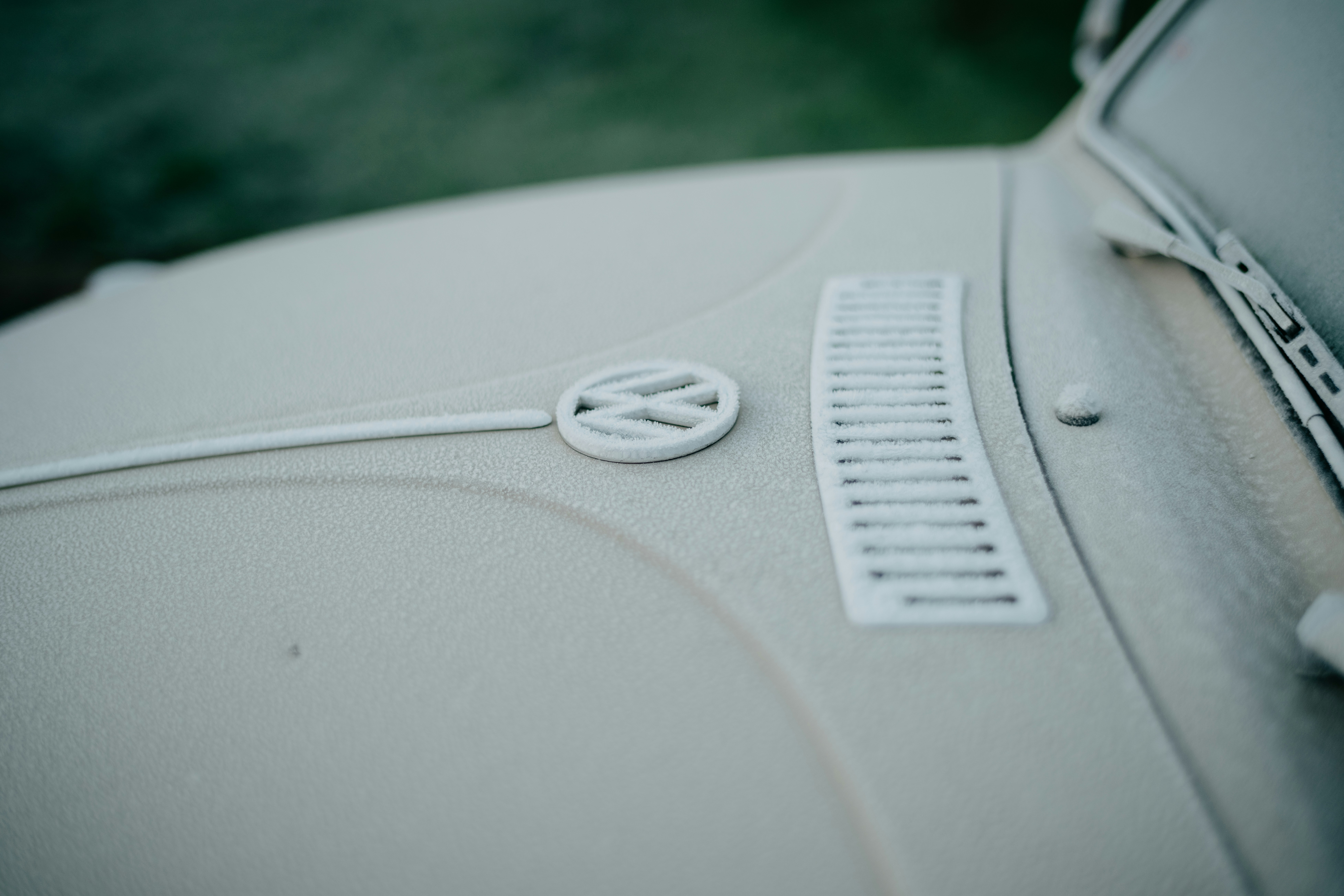 Close-up of a Classic VW Hood Ornament and Vented Grille