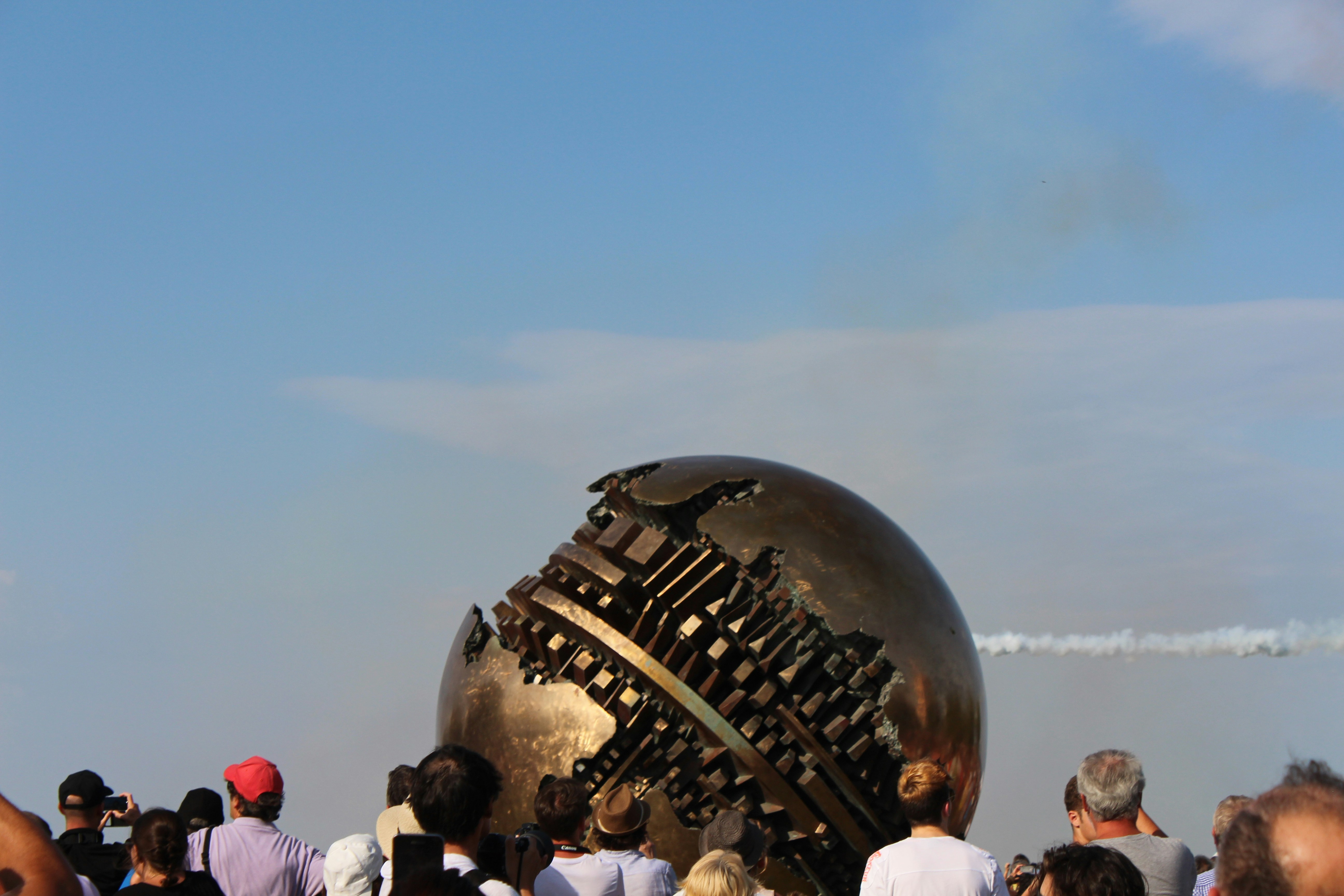 Sphere of Echoes: A Crowd Gazes at a Gleaming Atomic Sculpture