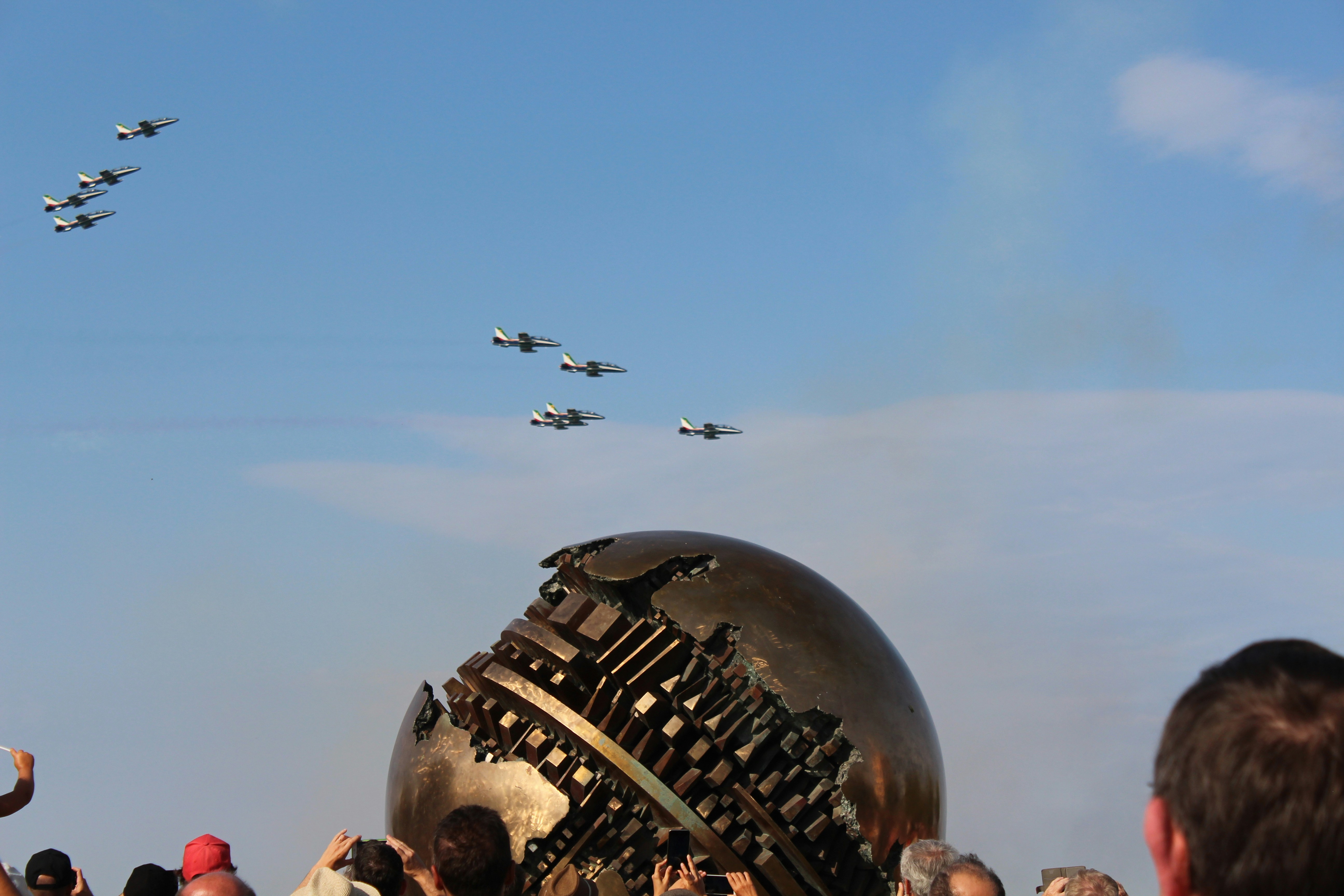A group of people watching airplanes fly overhead photo – Free Grey ...