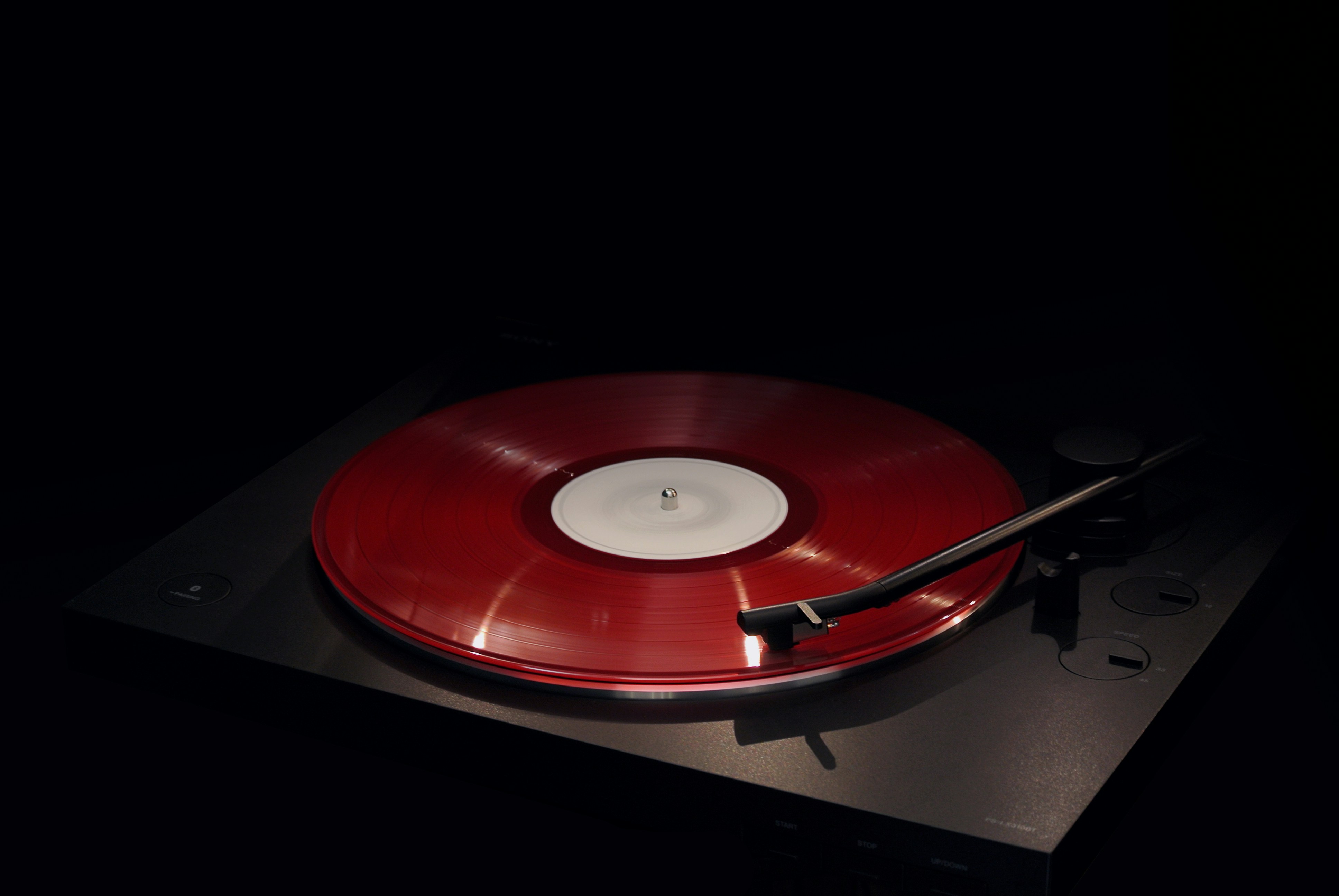 A red record player on a black surface photo – Free Music Image on Unsplash