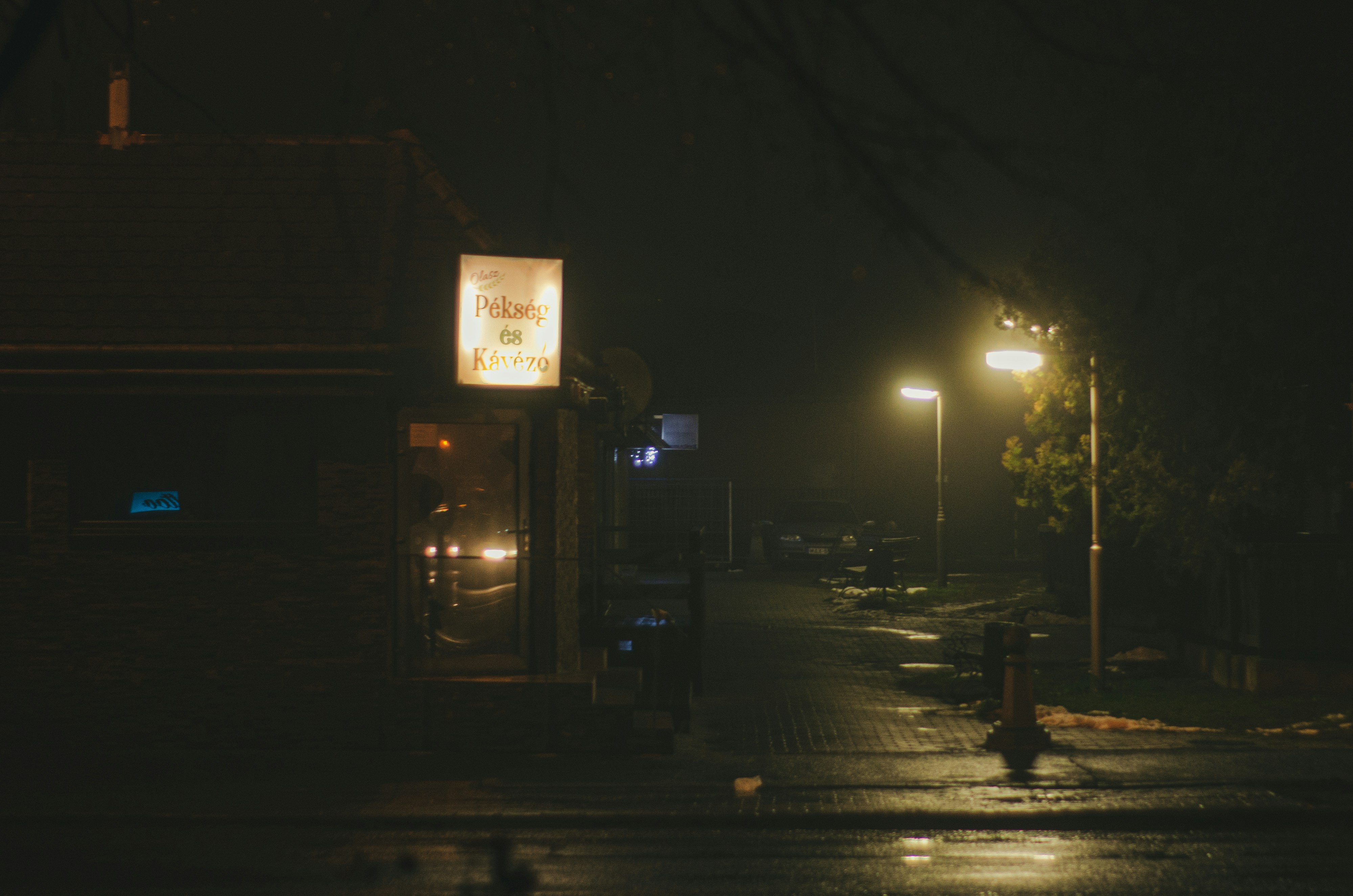 A dark street at night with street lights photo – Free Street Image on ...