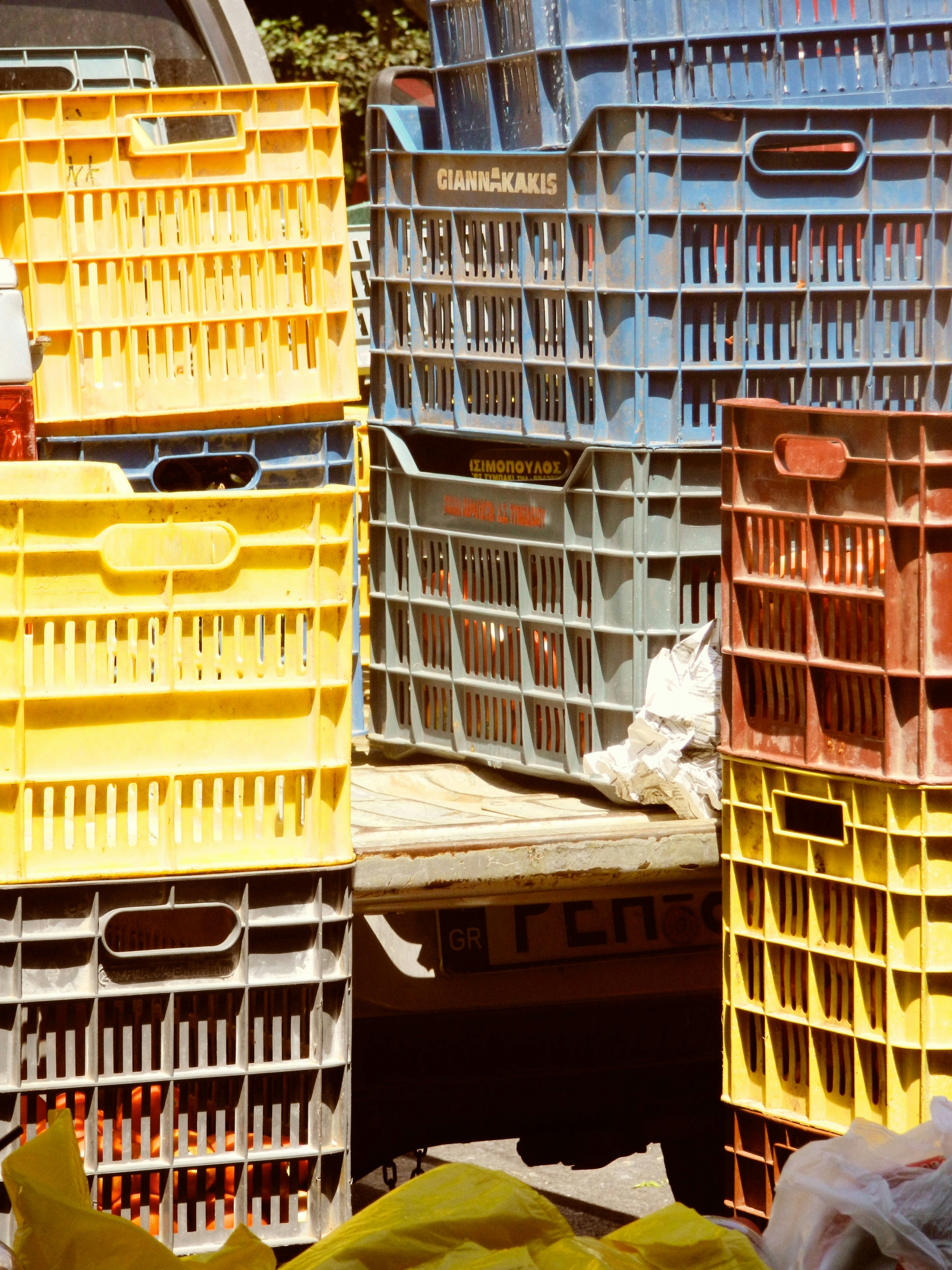 Stacked Crates in the Sunlit Yard: A Palette of Industrial Color