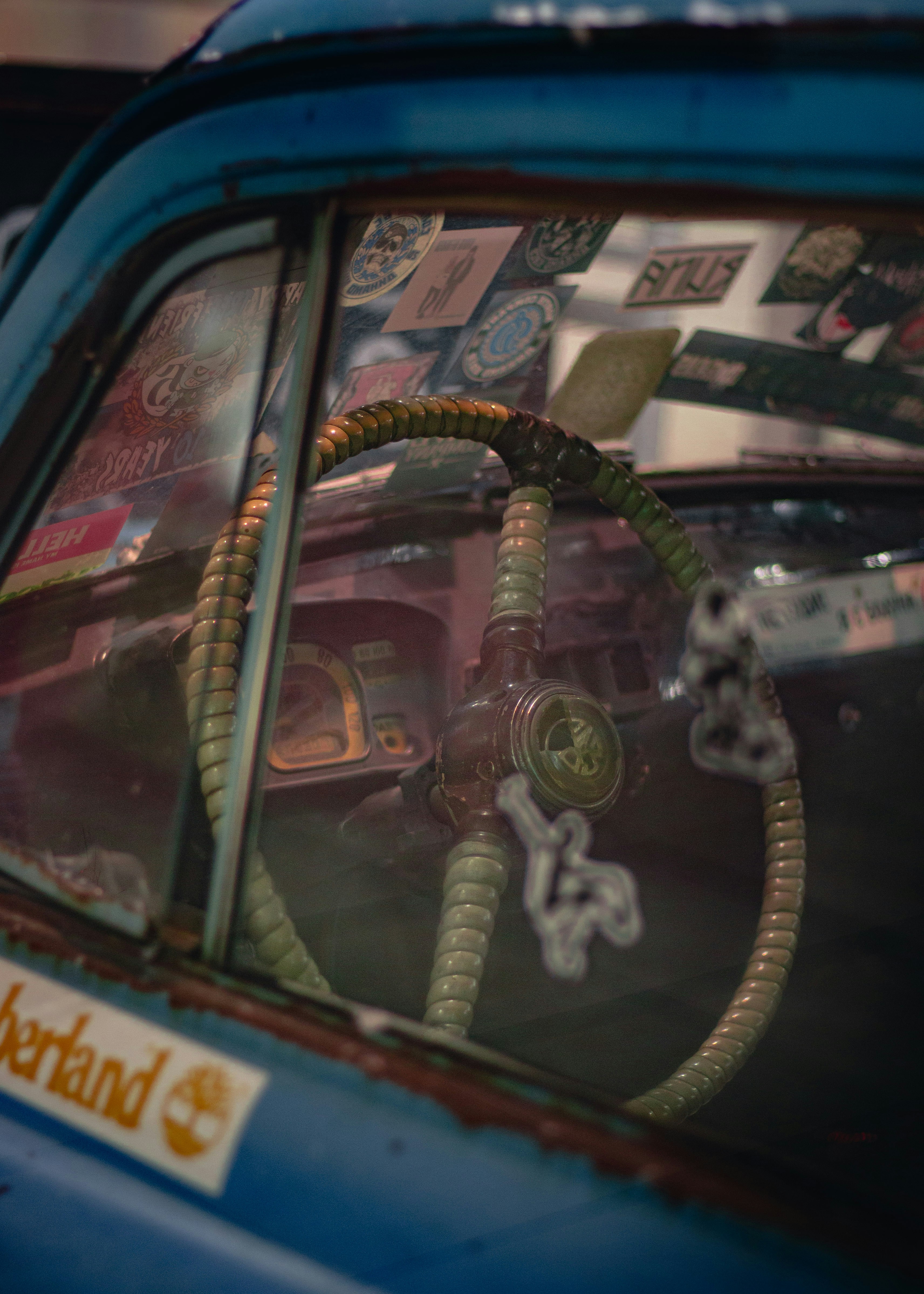 A blue car with a steering wheel and some stickers on it photo – Free ...