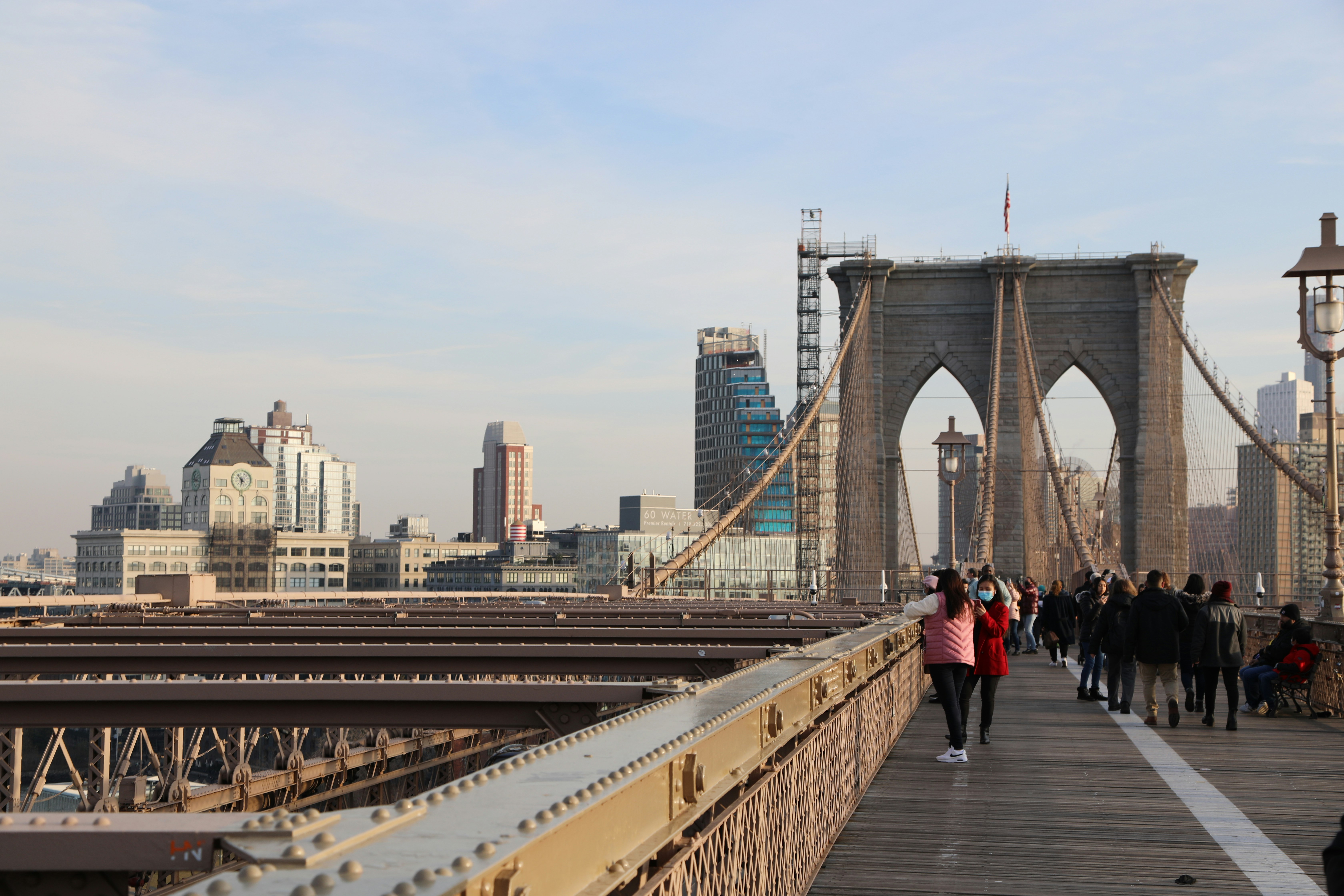 A group of people walking across a bridge photo – Free New york Image ...