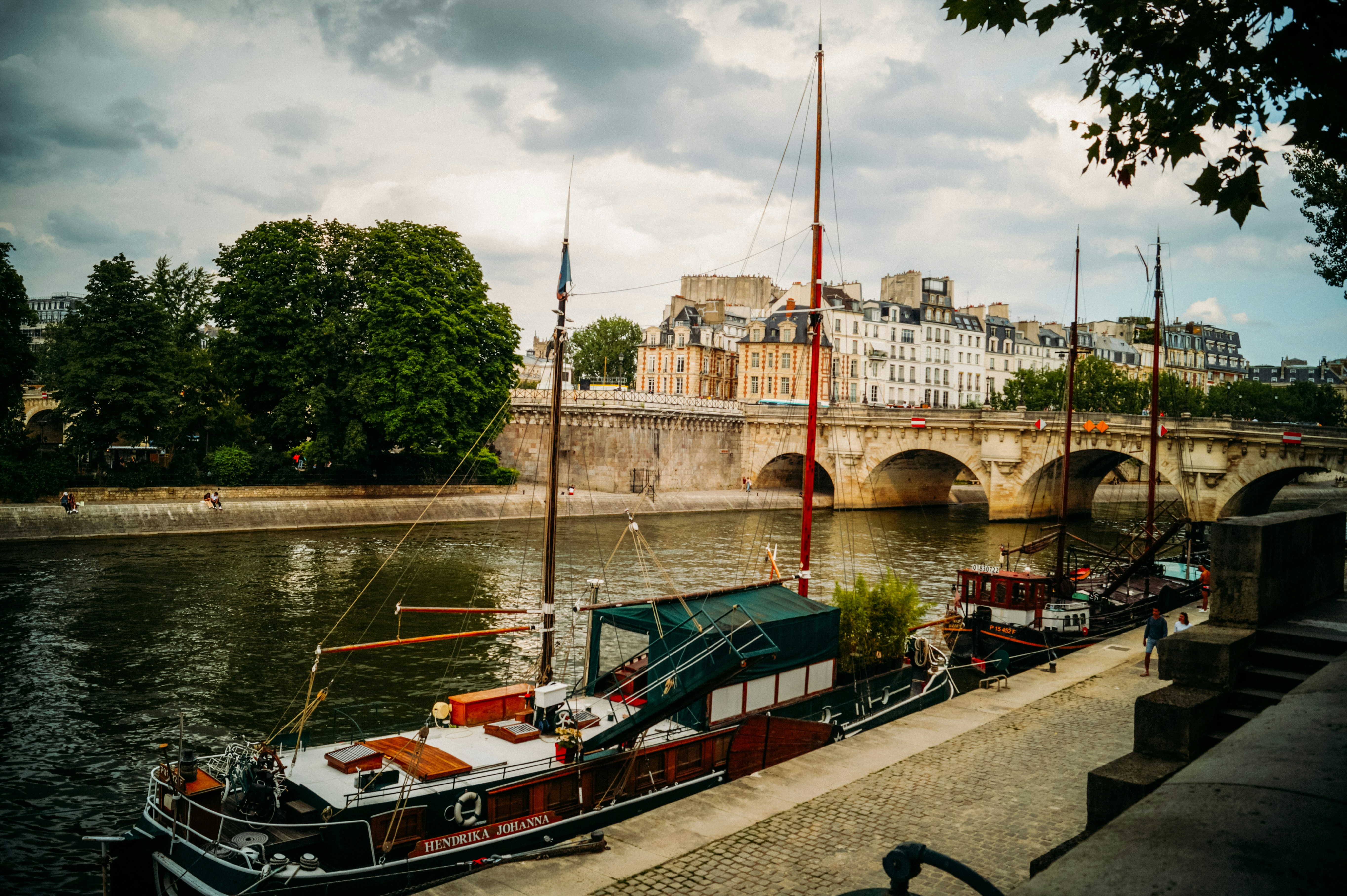 Boats Along the Seine Beneath a Historic Stone Bridge