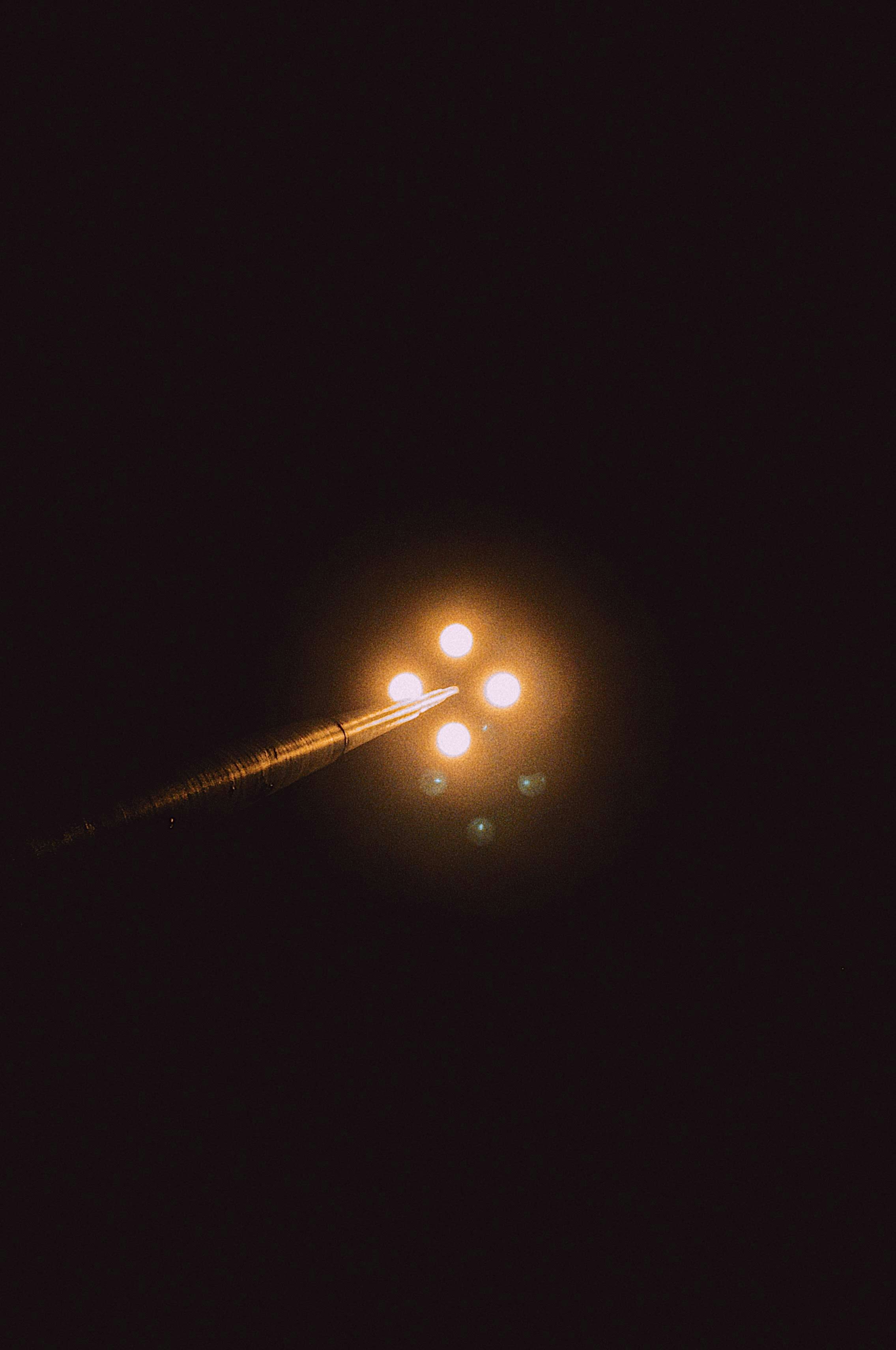 Quad-Lit Beacon: Four Warm Orbs Piercing the Night