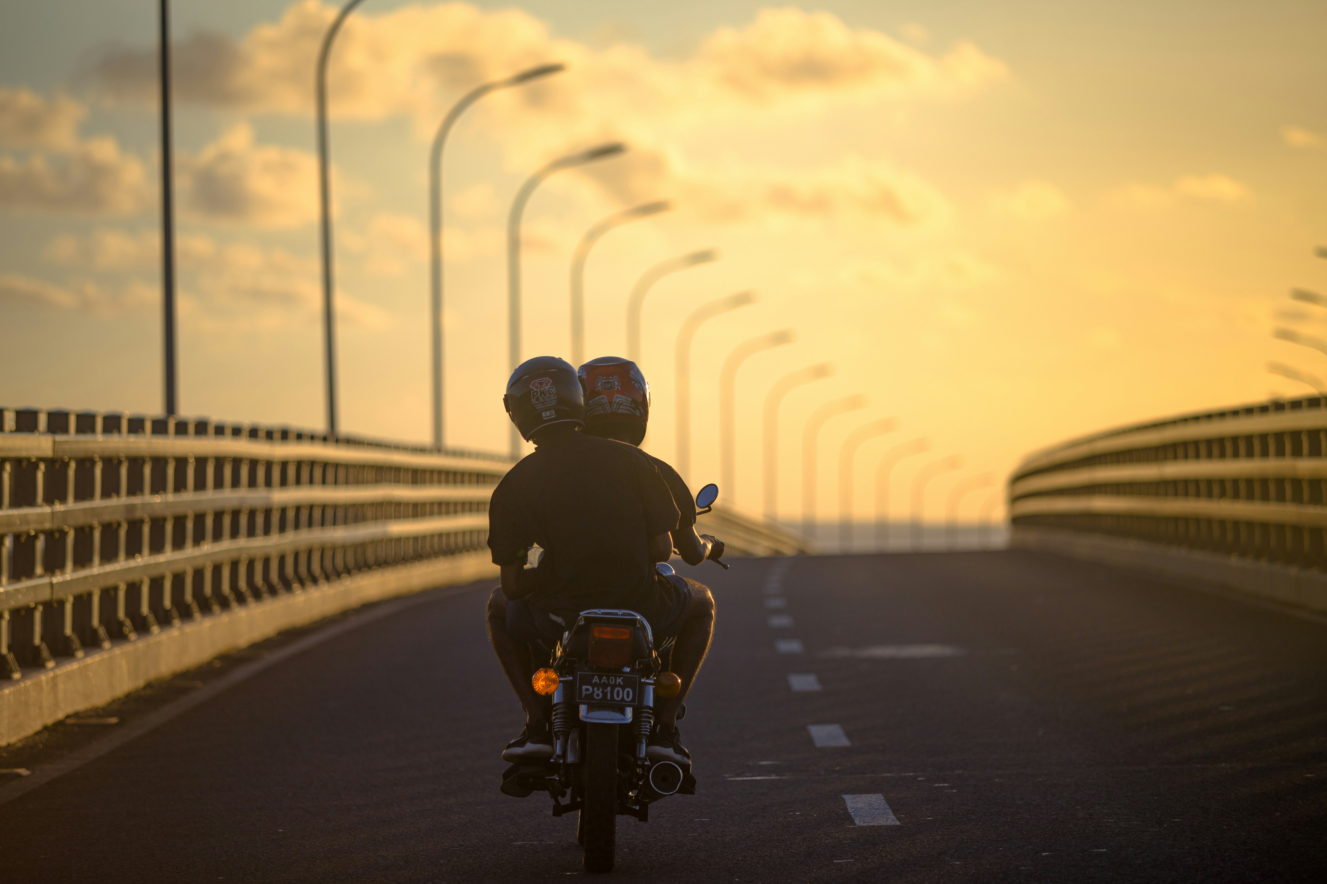 Two people riding a motorcycle on a bridge photo – Free Maldives Image ...