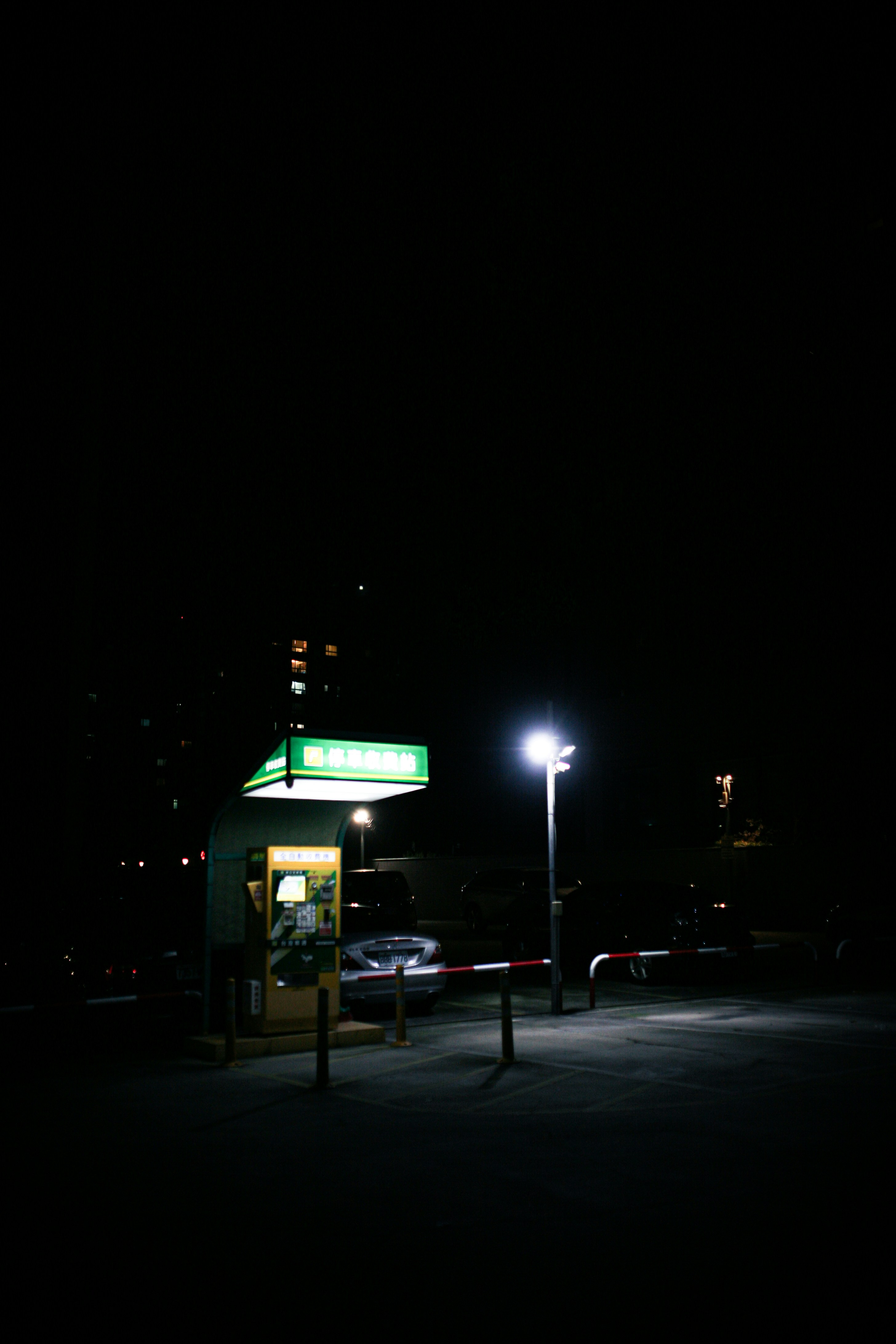 A gas station at night with a lit up sign photo – Free Bus stop Image ...