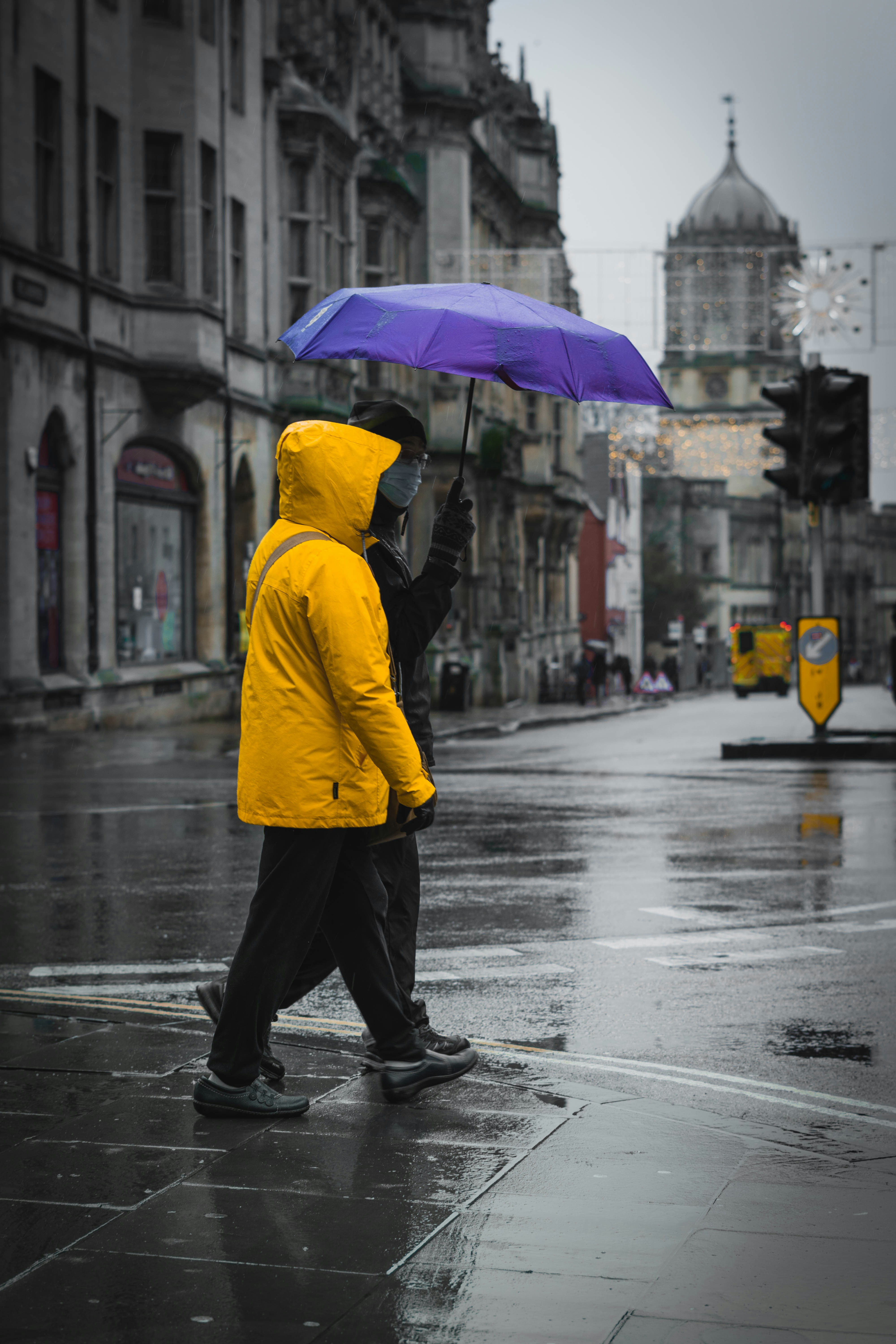 two people walking in the rain with an umbrella