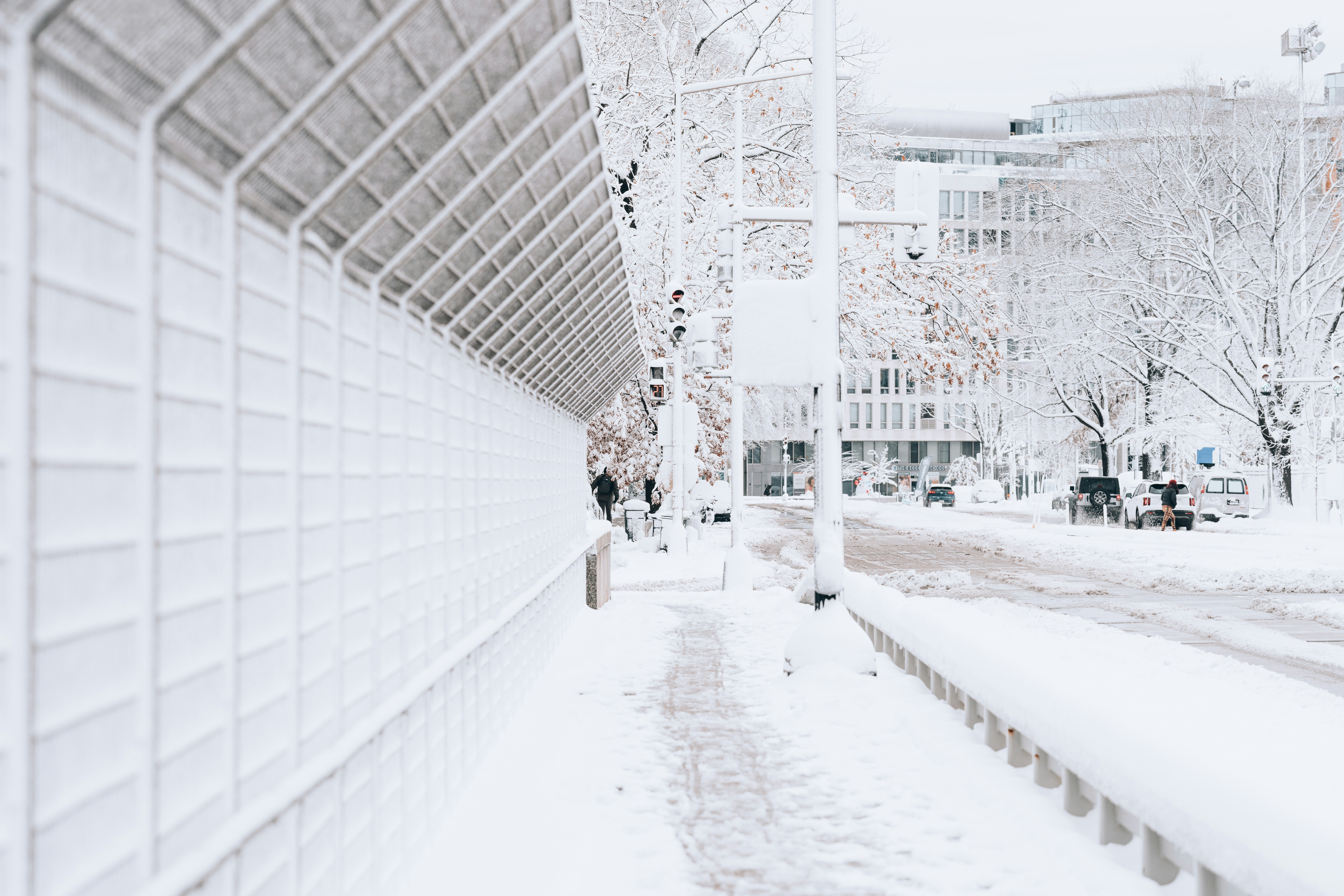 Snow-Quiet City Walk: A Receding Wall and Distant Figures