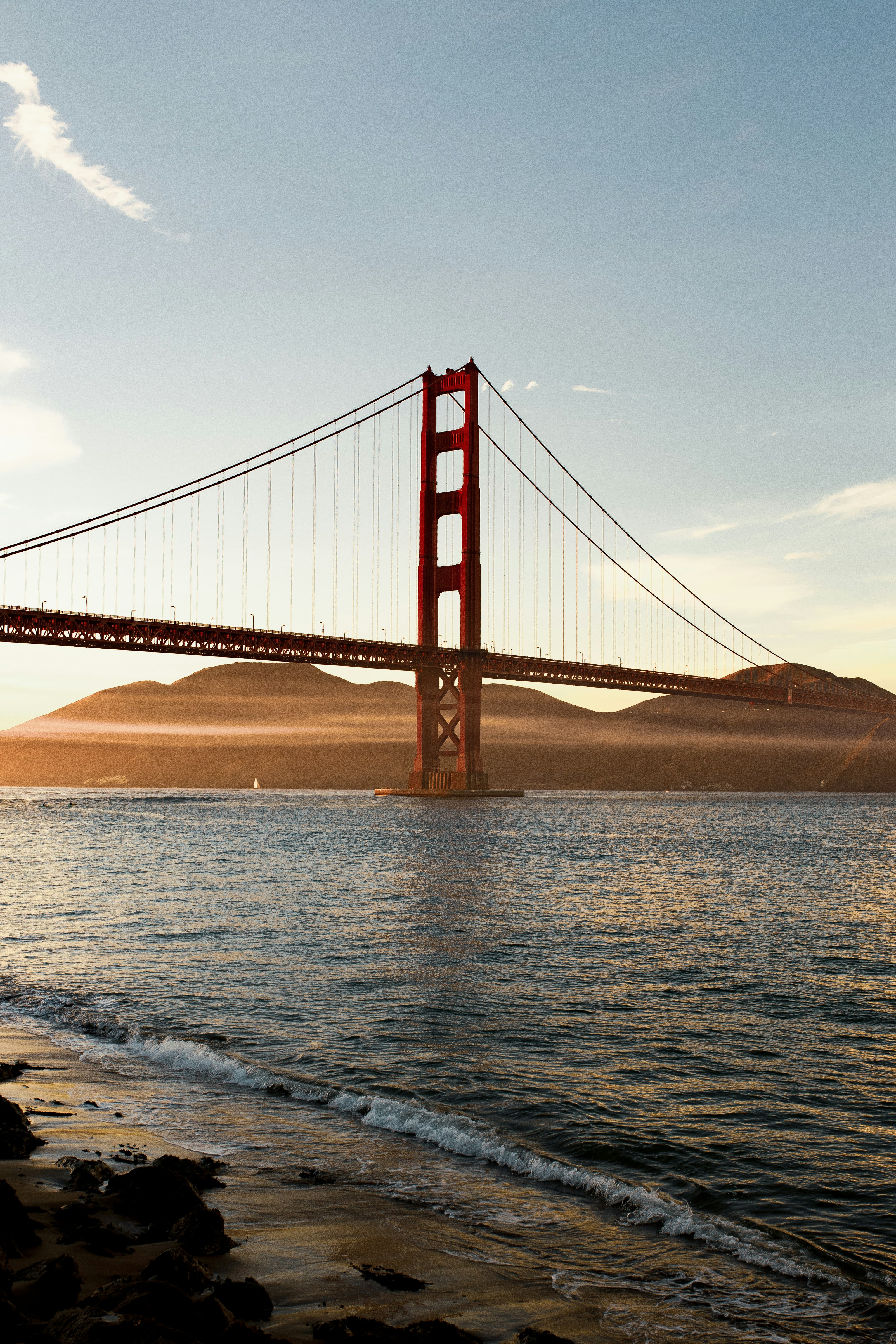 Crimson Span at Dusk: The Golden Gate Tower Over a Quiet Bay