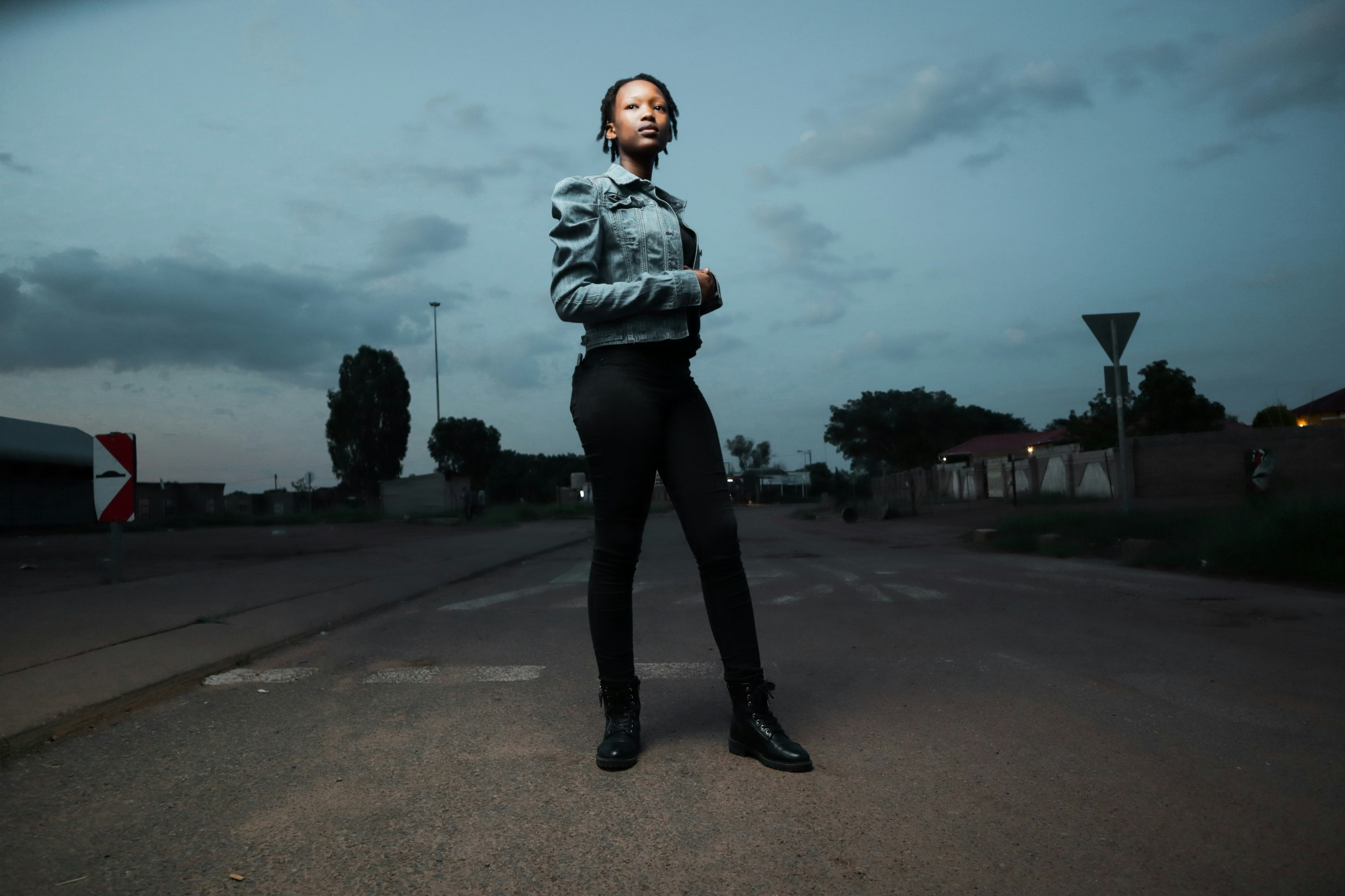 A woman standing in the middle of a street photo – Free Majaneng Image ...
