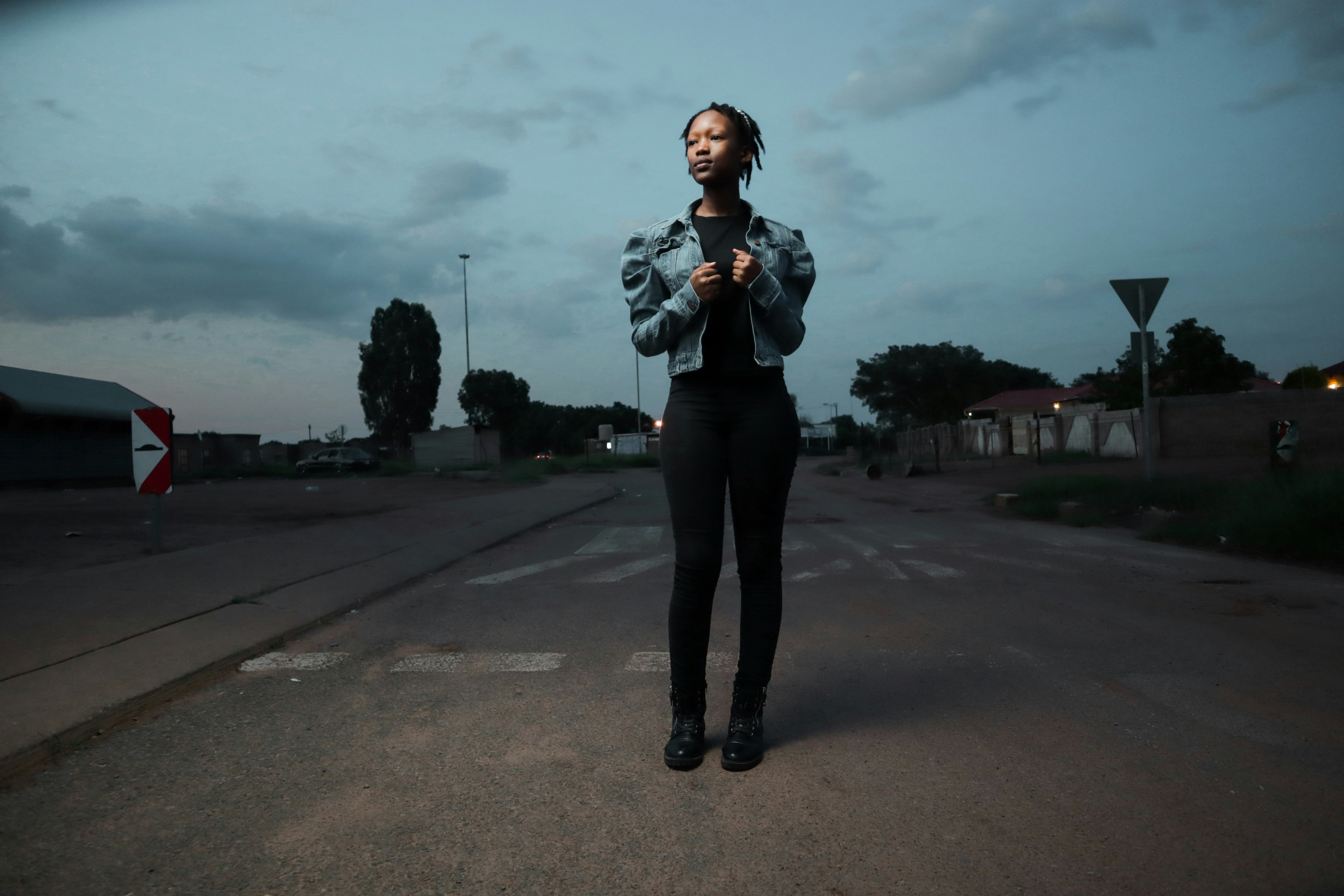 A woman standing in the middle of a street photo – Free Majaneng Image ...