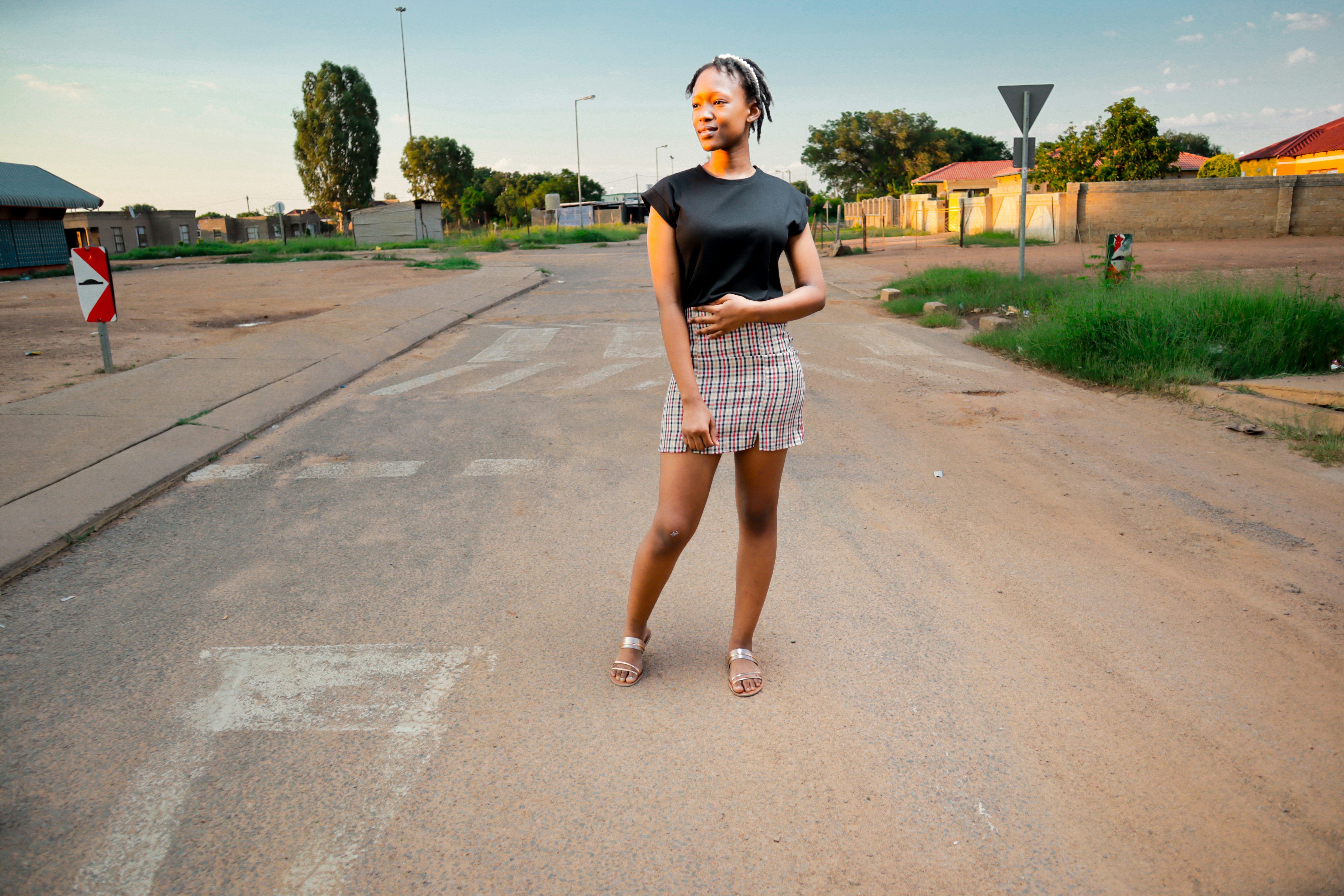 Sunlit Street Portrait at a Quiet Suburban Crossing