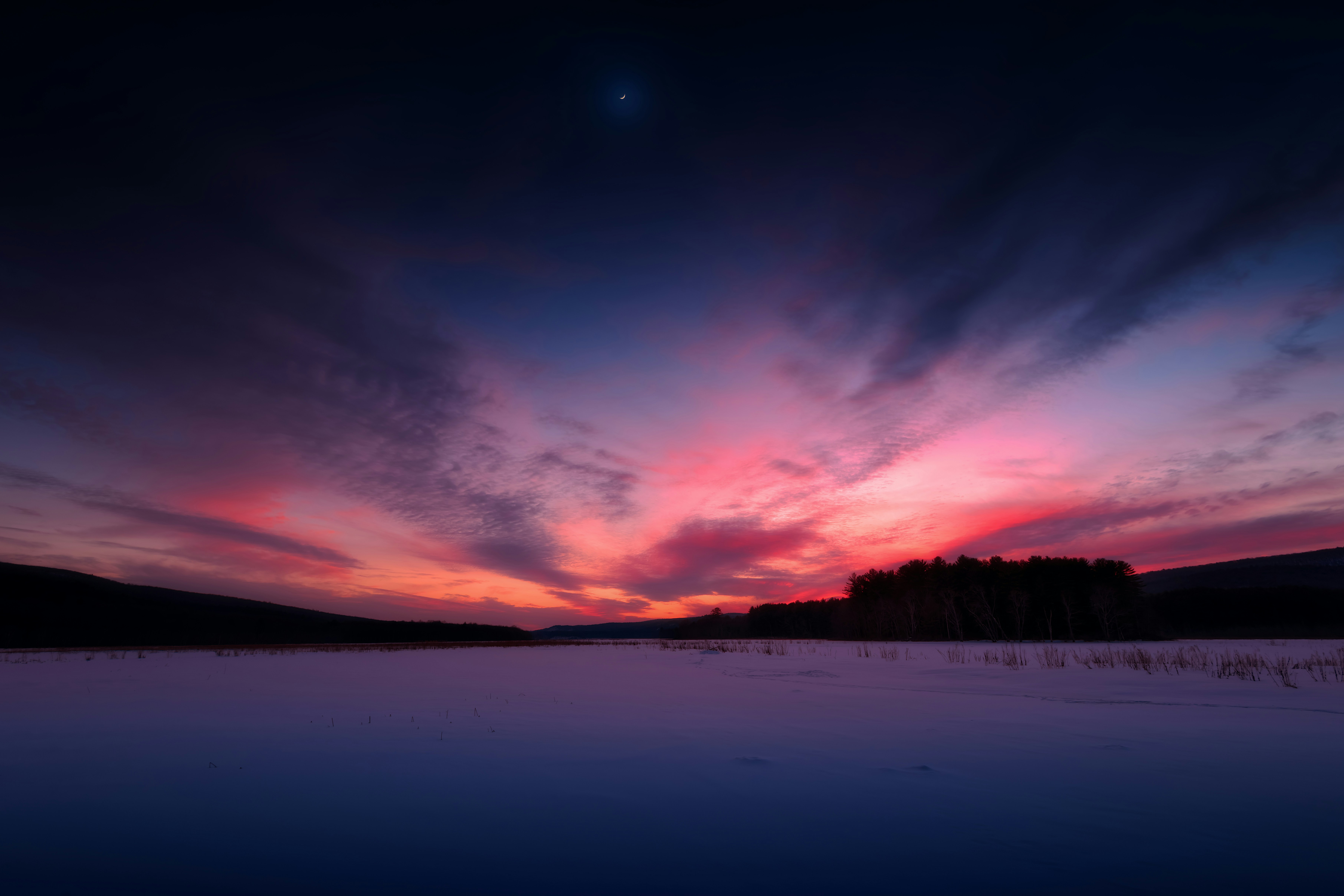 Crimson Dawn over a Quiet Snowfield