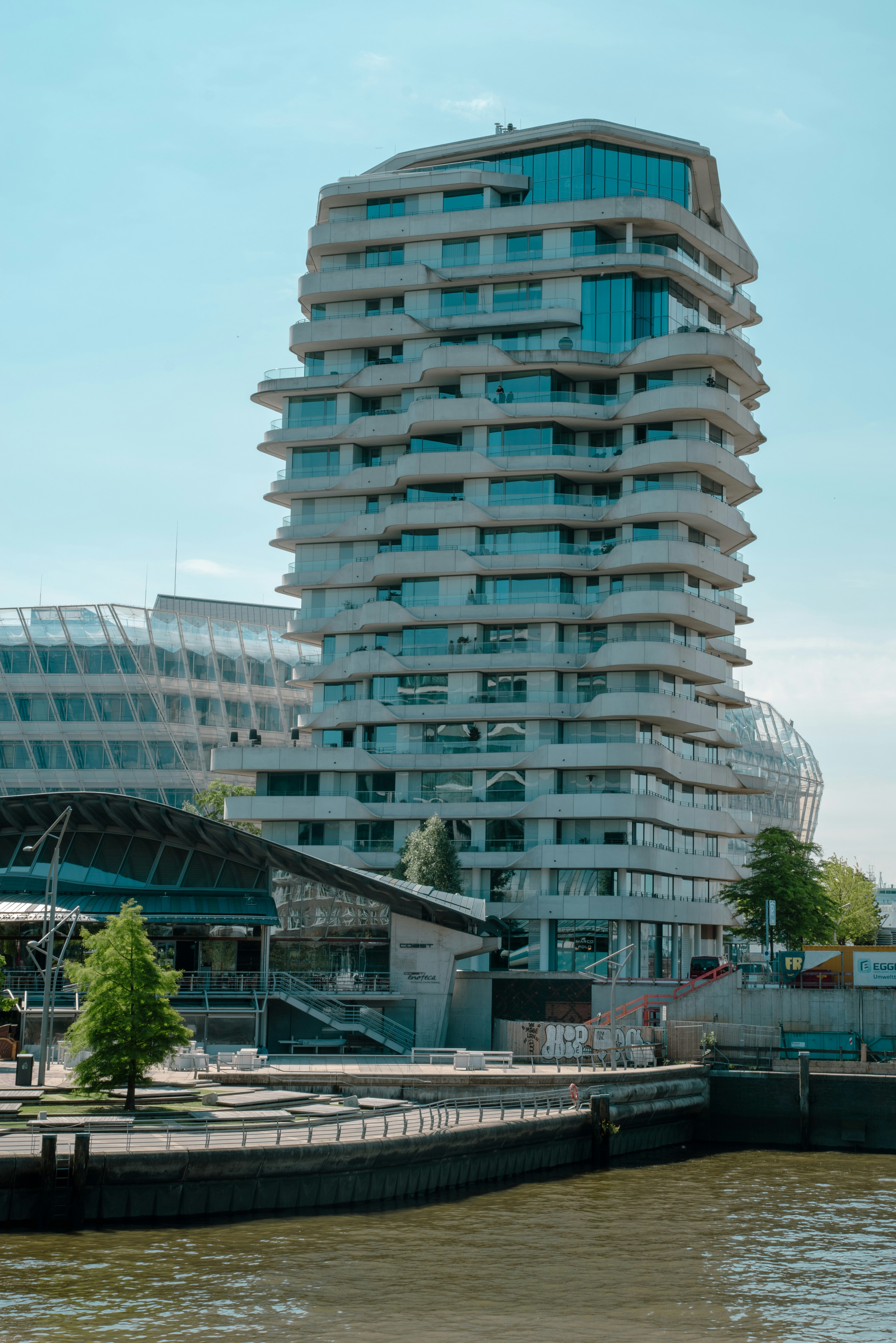 a tall building next to a body of water