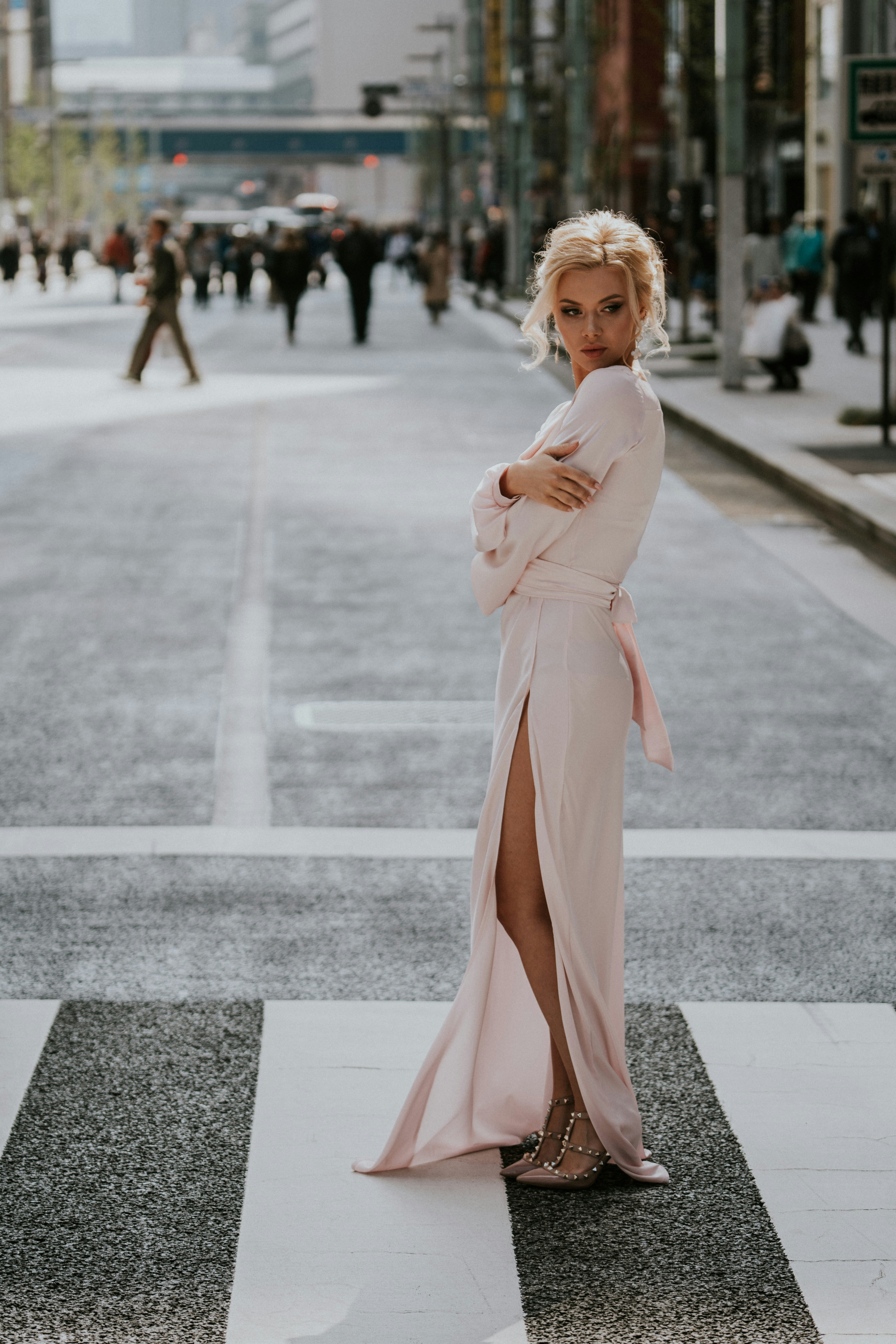 Pastel Silk on a City Crosswalk: A Poised Portrait in Subtle Evening Light