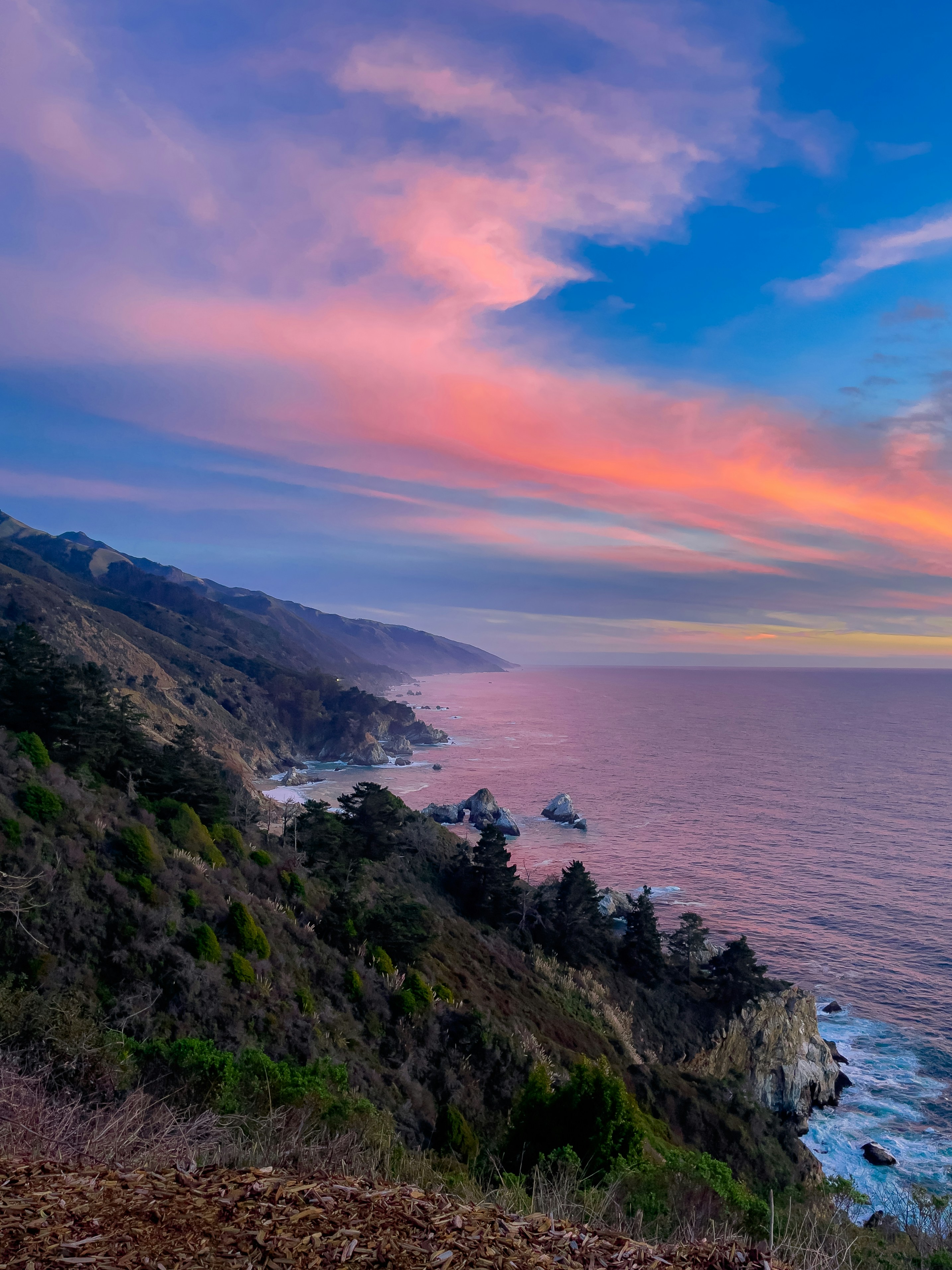 Sunset Over Coastal Cliffs: Pink-Blue Sky Meeting the Pacific