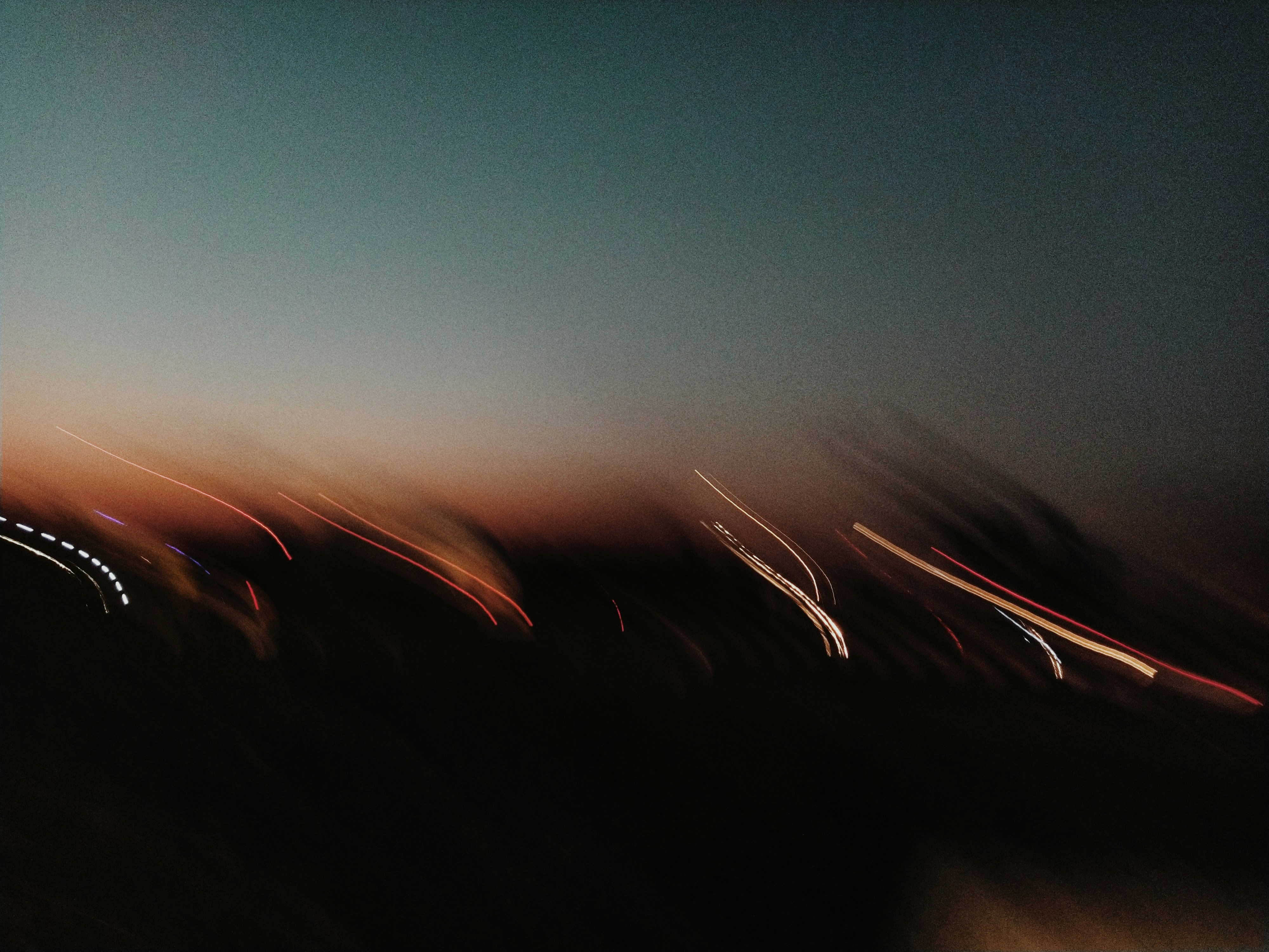 Blurred city lights against a twilight sky, creating an abstract urban scene.