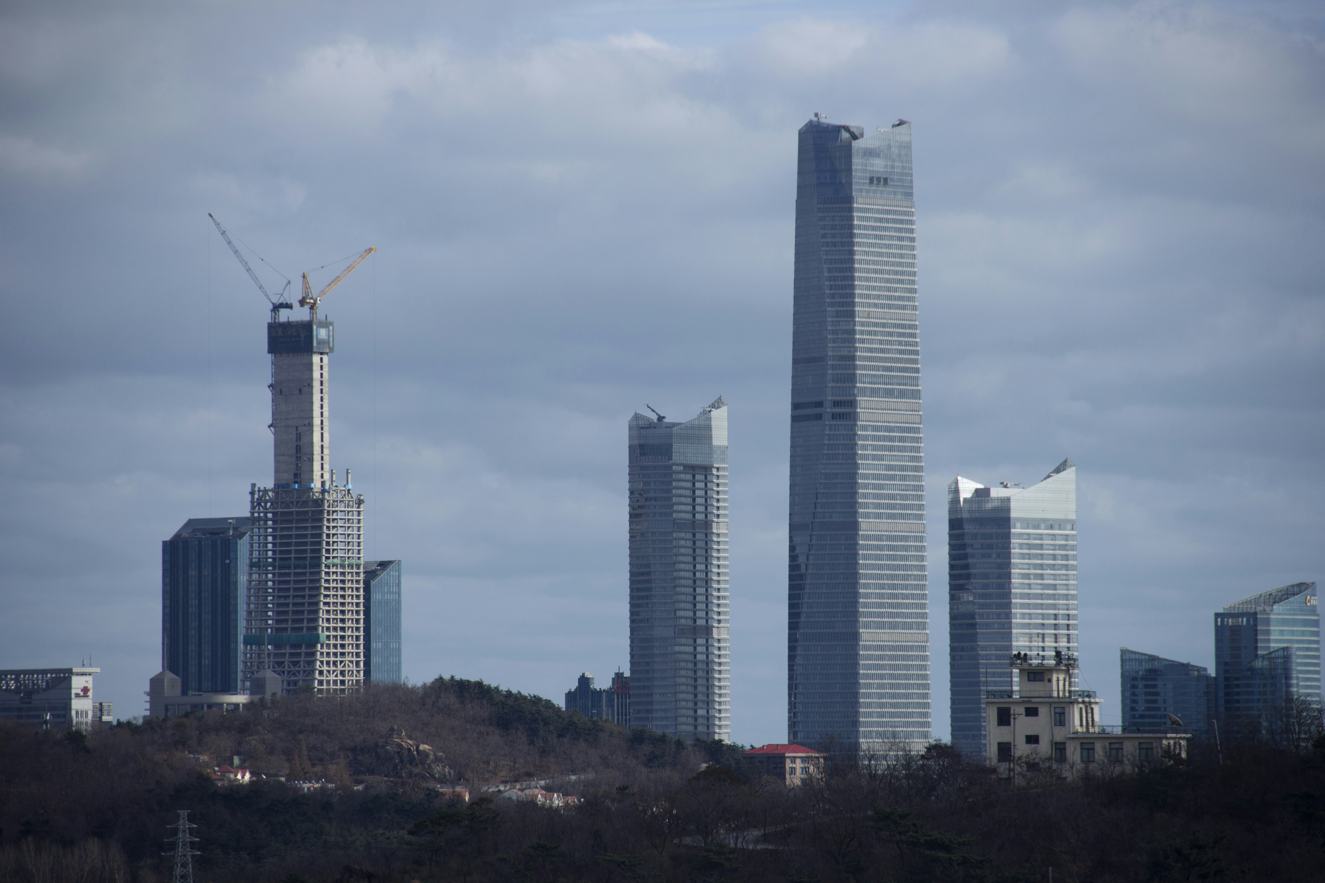 A group of tall buildings in a city photo – Free Tsingtao Image on Unsplash