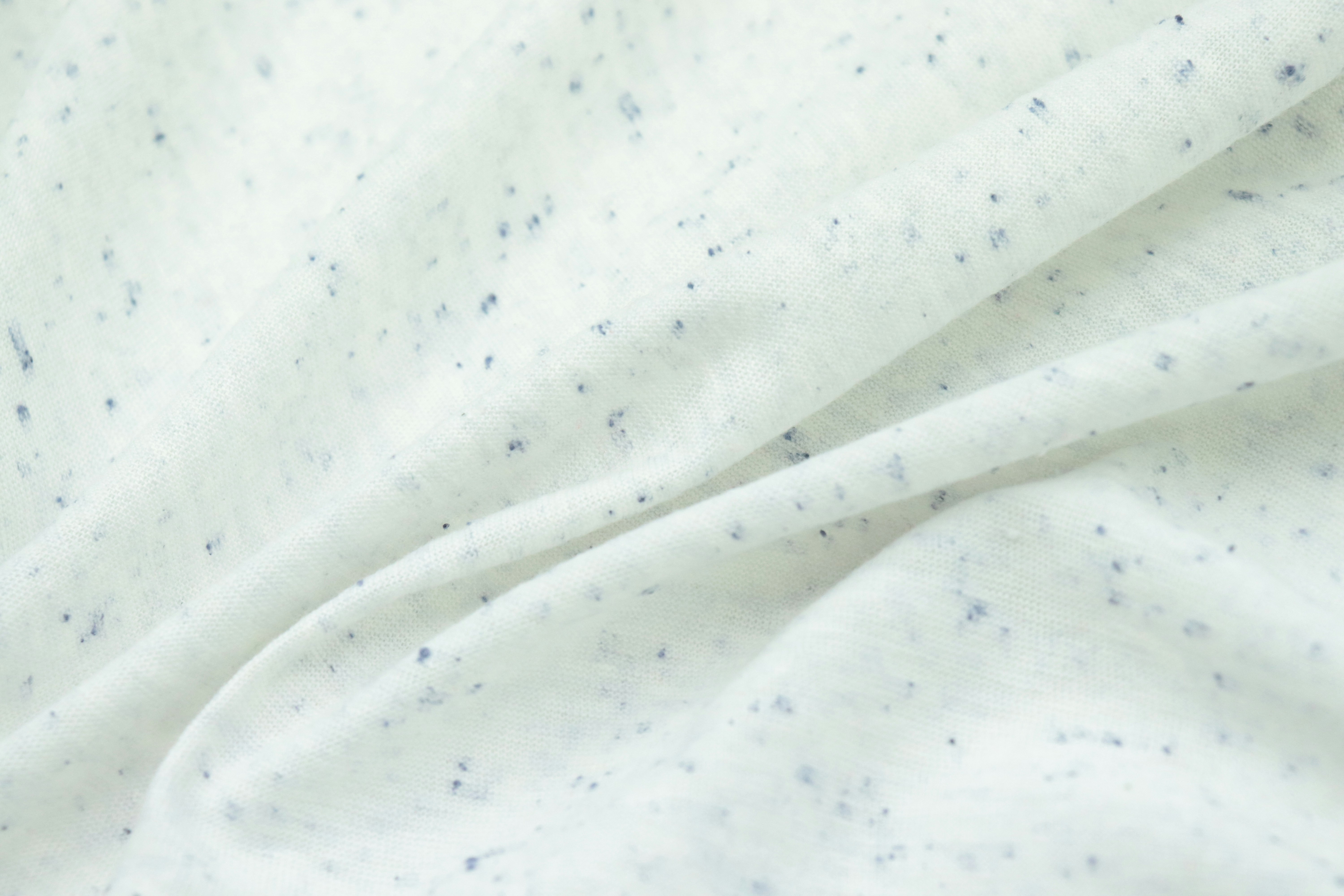 A close up of a white fabric with blue speckles photo – Free Linen ...