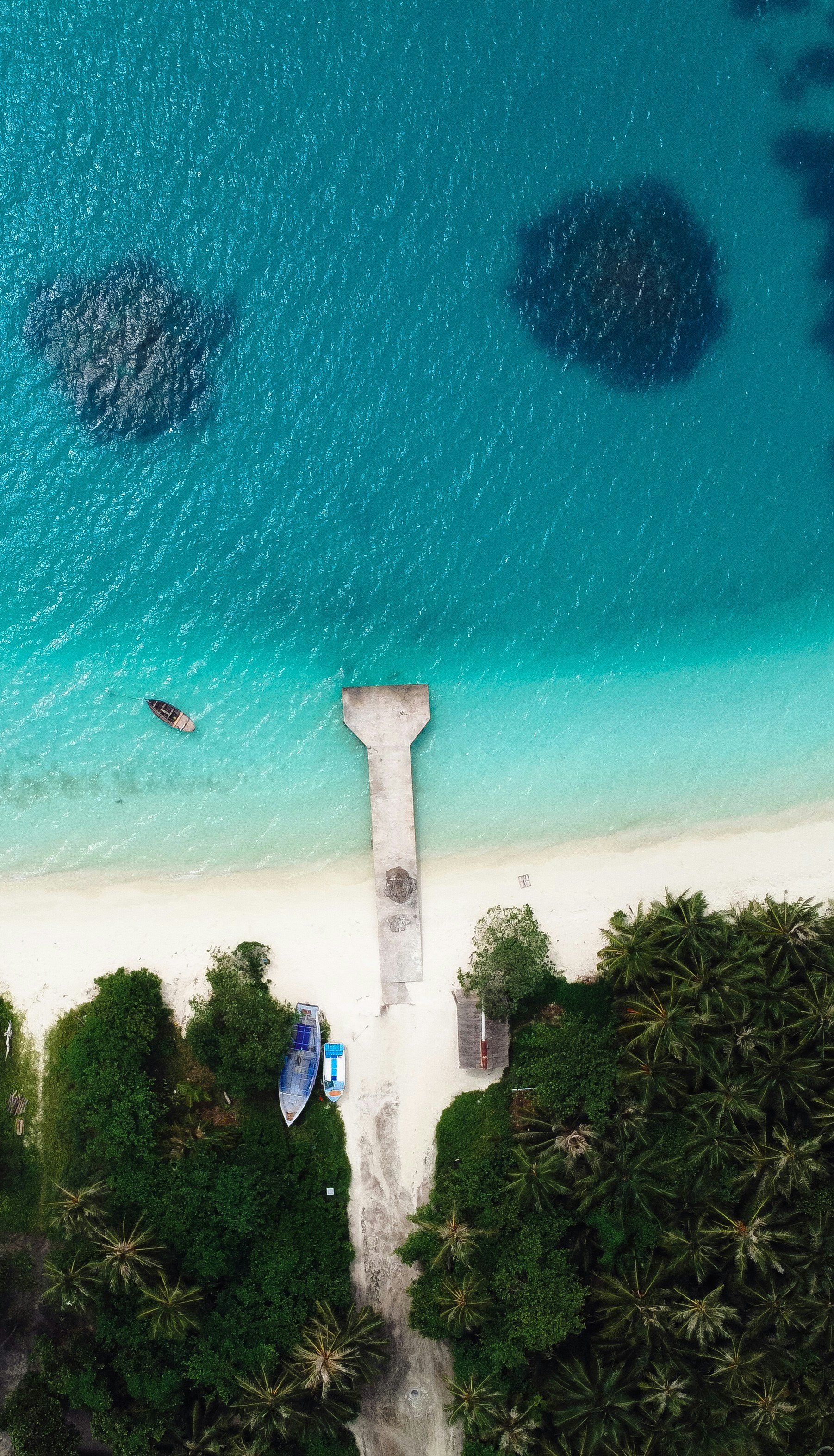 Shoreline Convergence: A Concrete Pier Reaching the Turquoise Sea