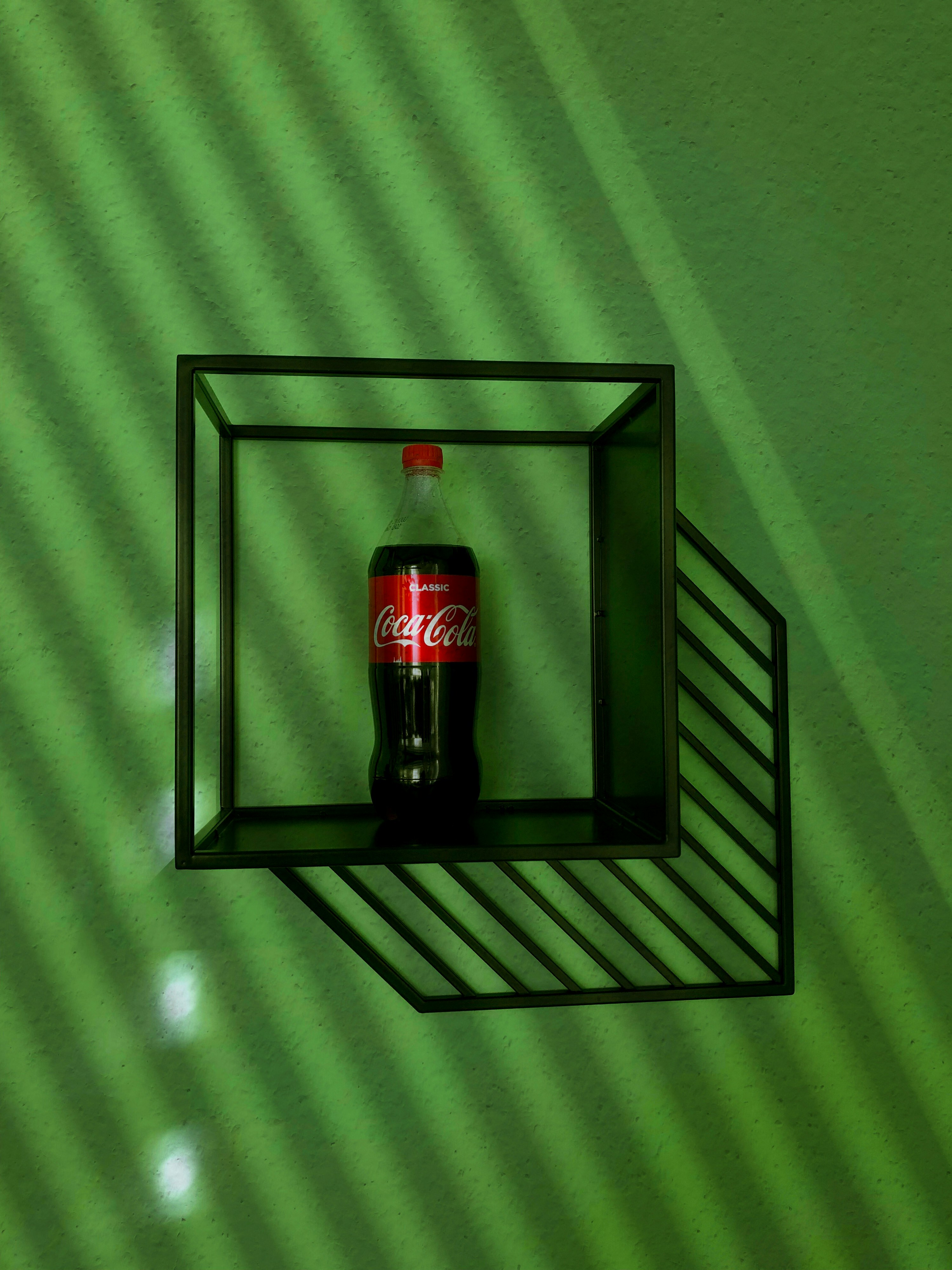 A coca - cola bottle in a shadow box on a green wall photo – Free Coke ...
