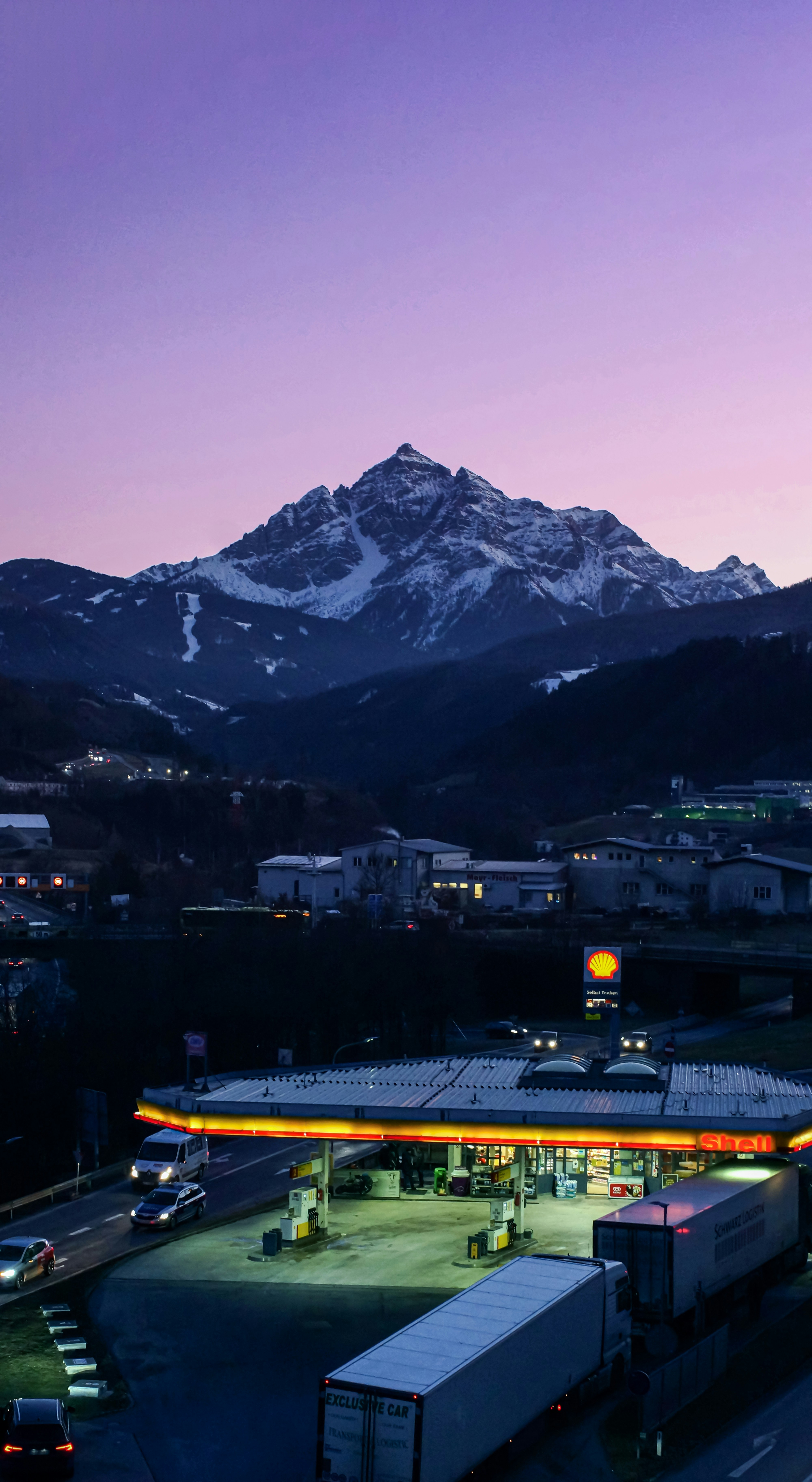a gas station with mountains in the background