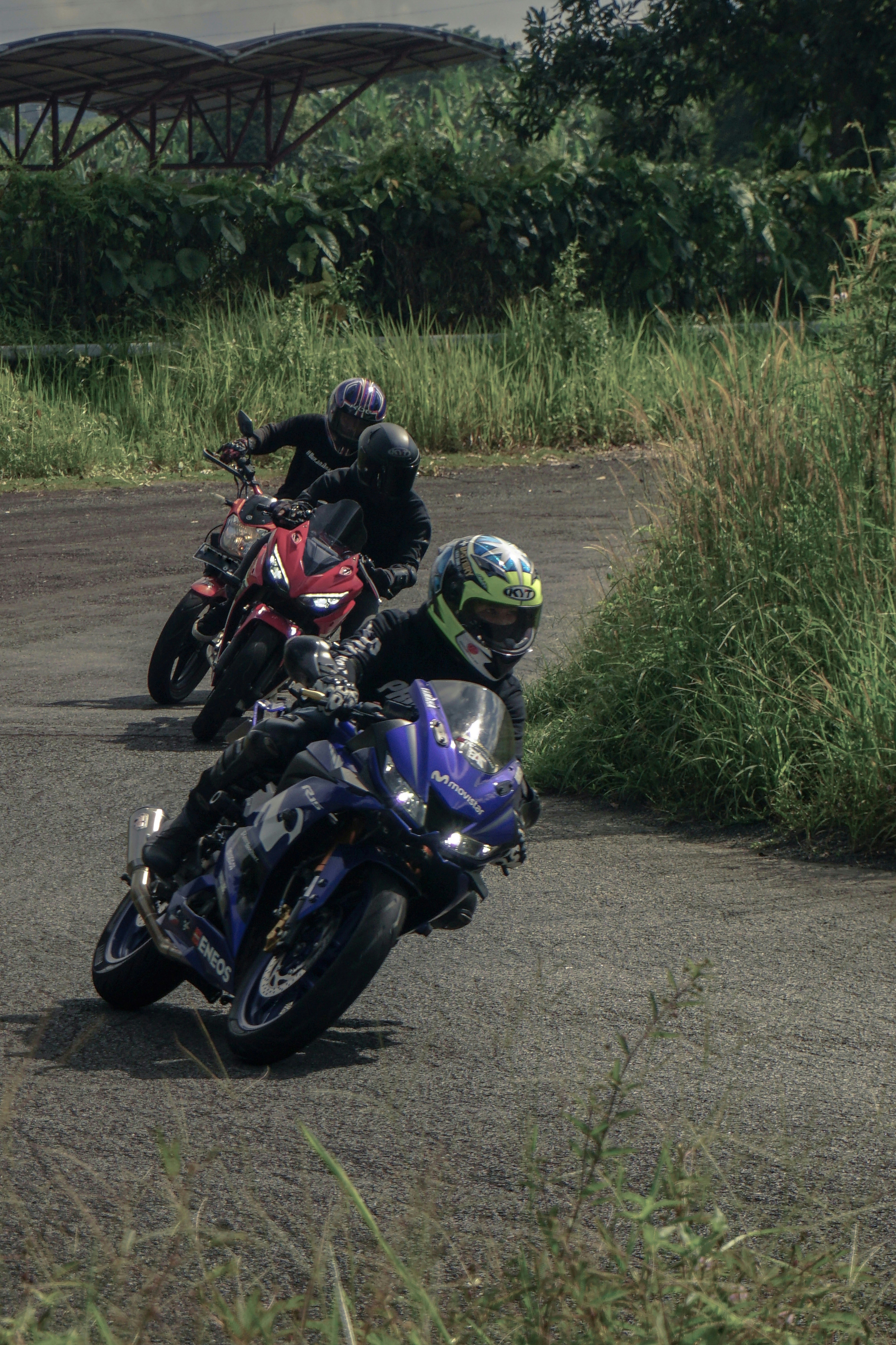Two people riding motorcycles on a paved road photo – Free Sirkuit ...