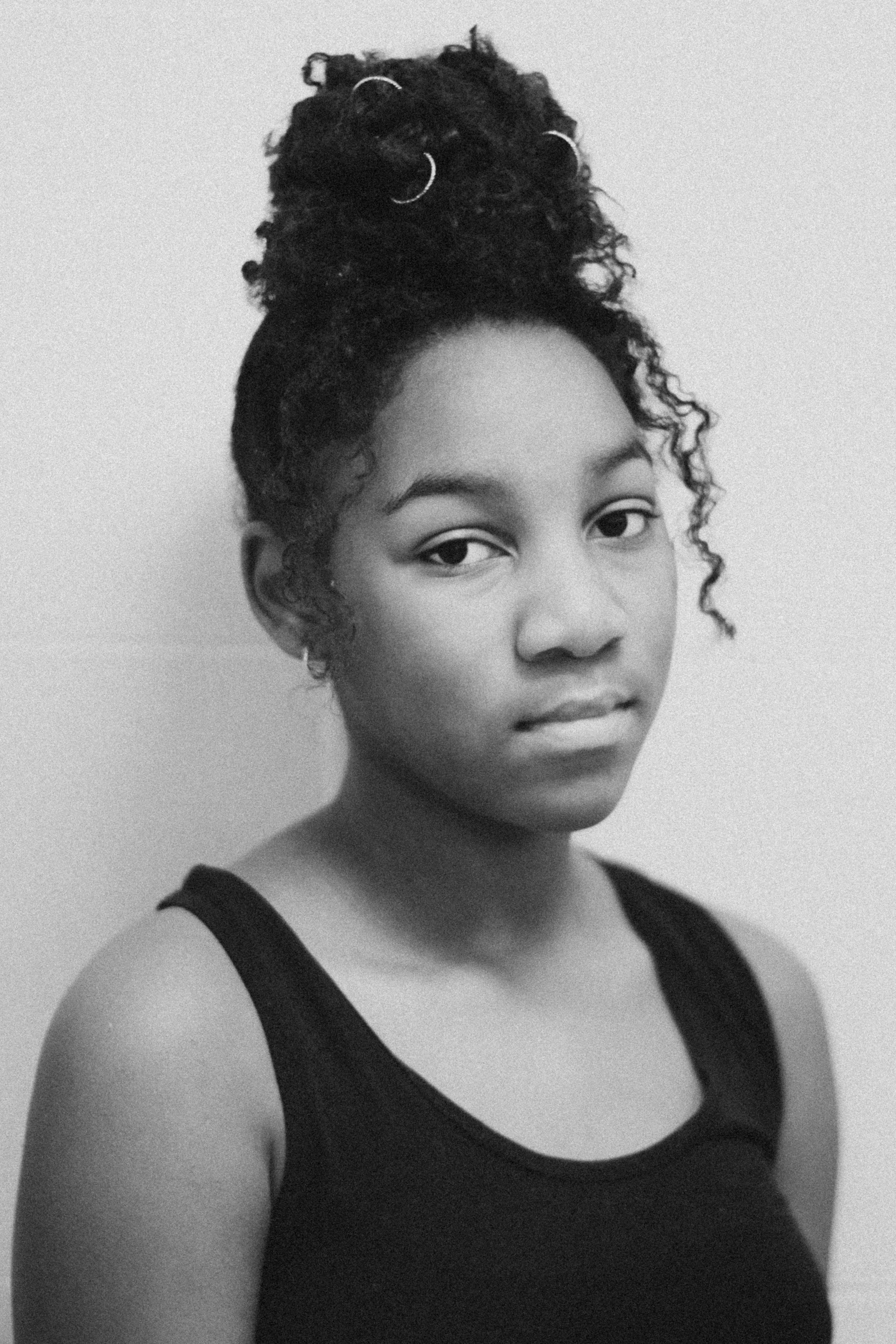 a black and white photo of a woman with curly hair