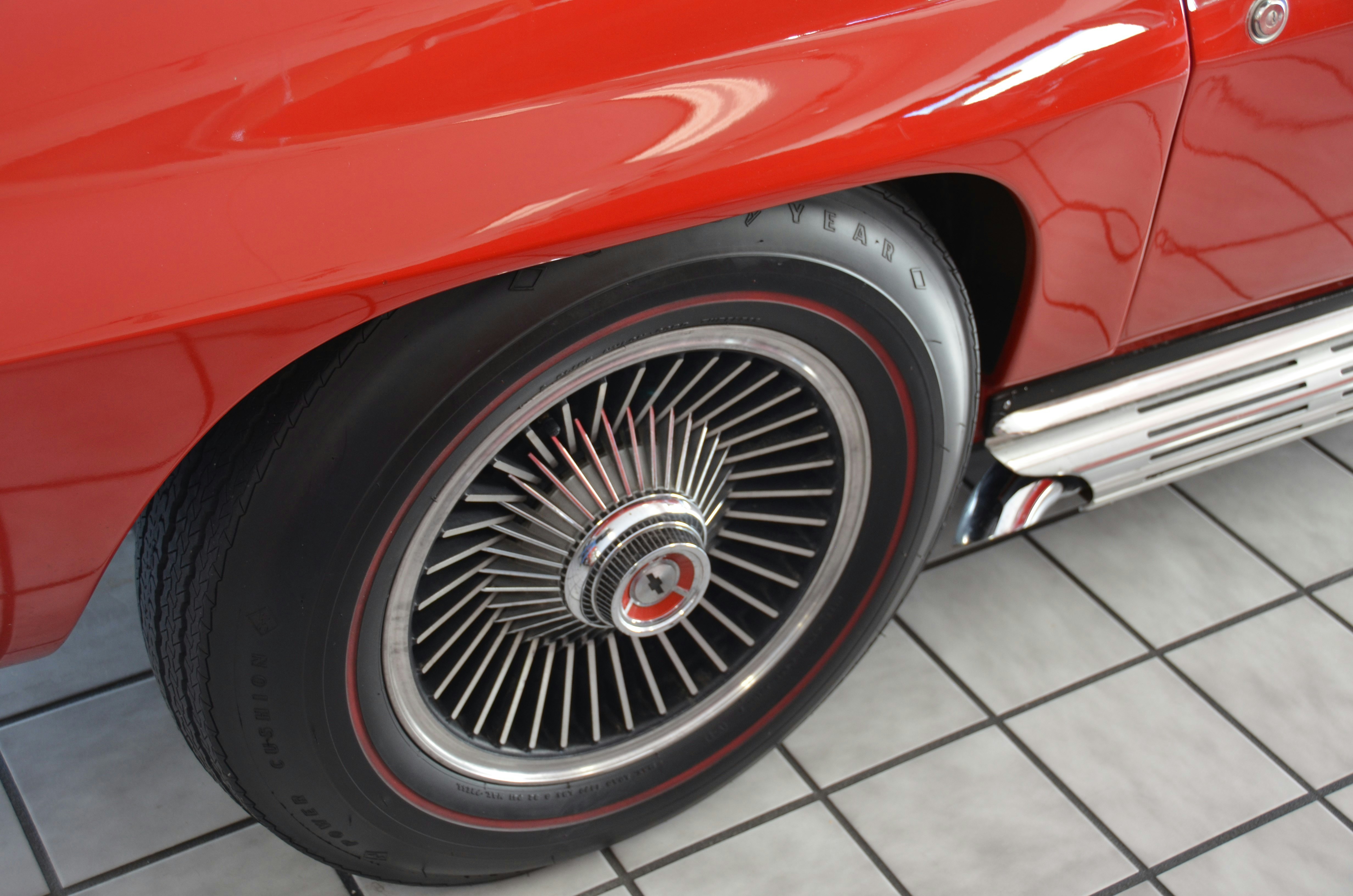 A close up of a red car on a tile floor photo – Free Tire Image on Unsplash
