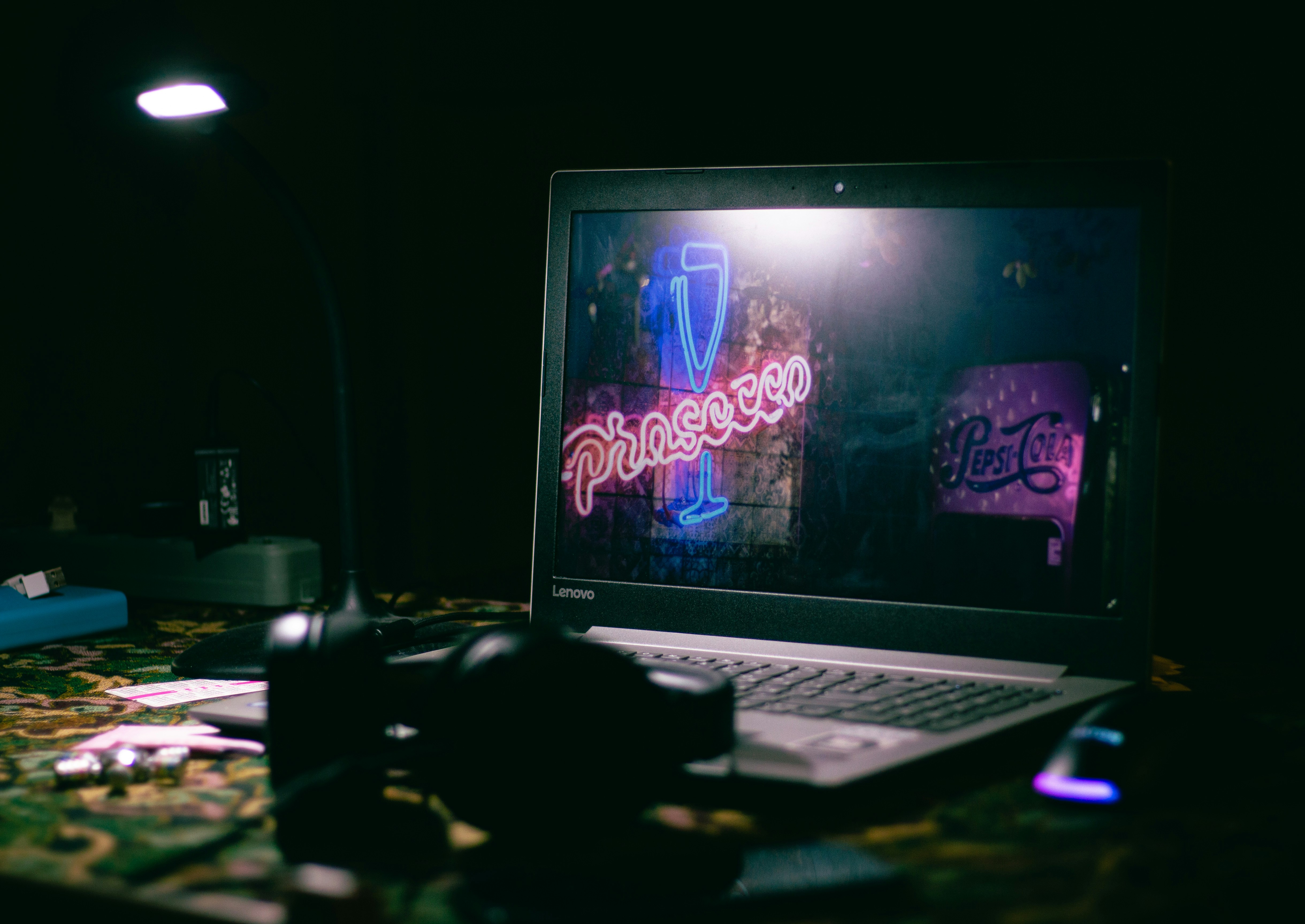 Neon Echoes on a Dim Desk: A Laptop Glow Framing a Moment