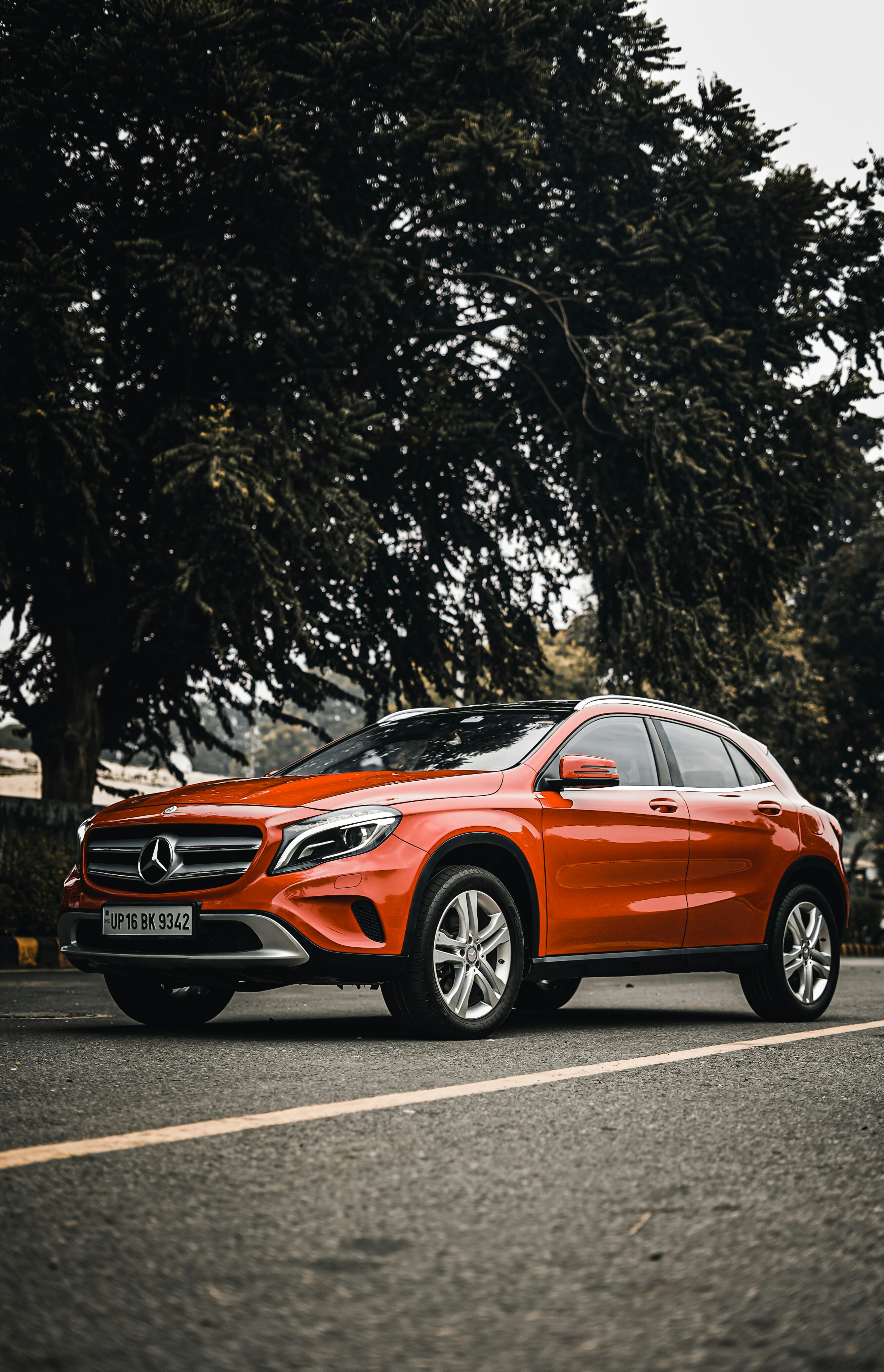 A red mercedes suv parked on the side of the road photo – Free Delhi ...