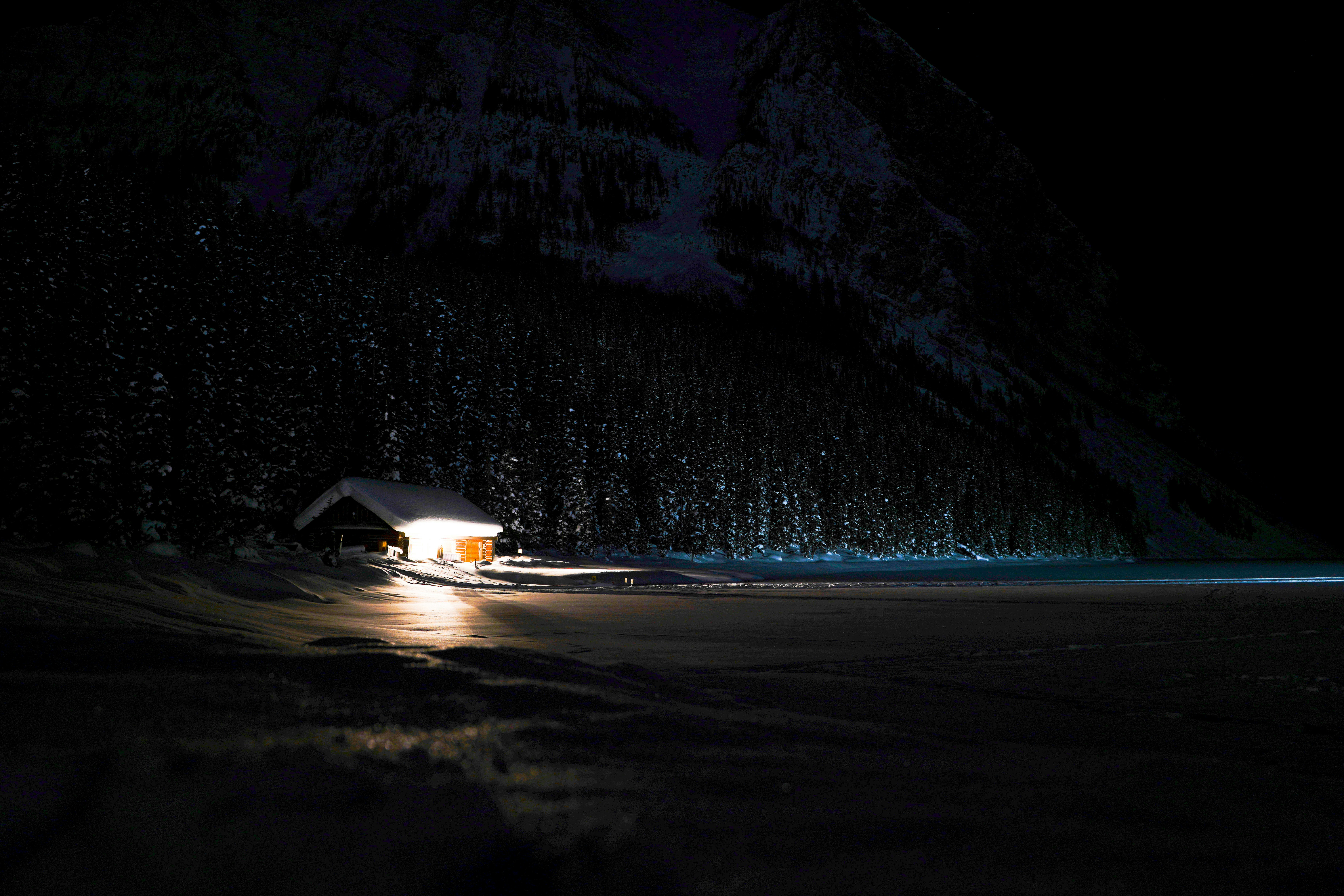 Cabin Glow on a Snowbound Shoreline