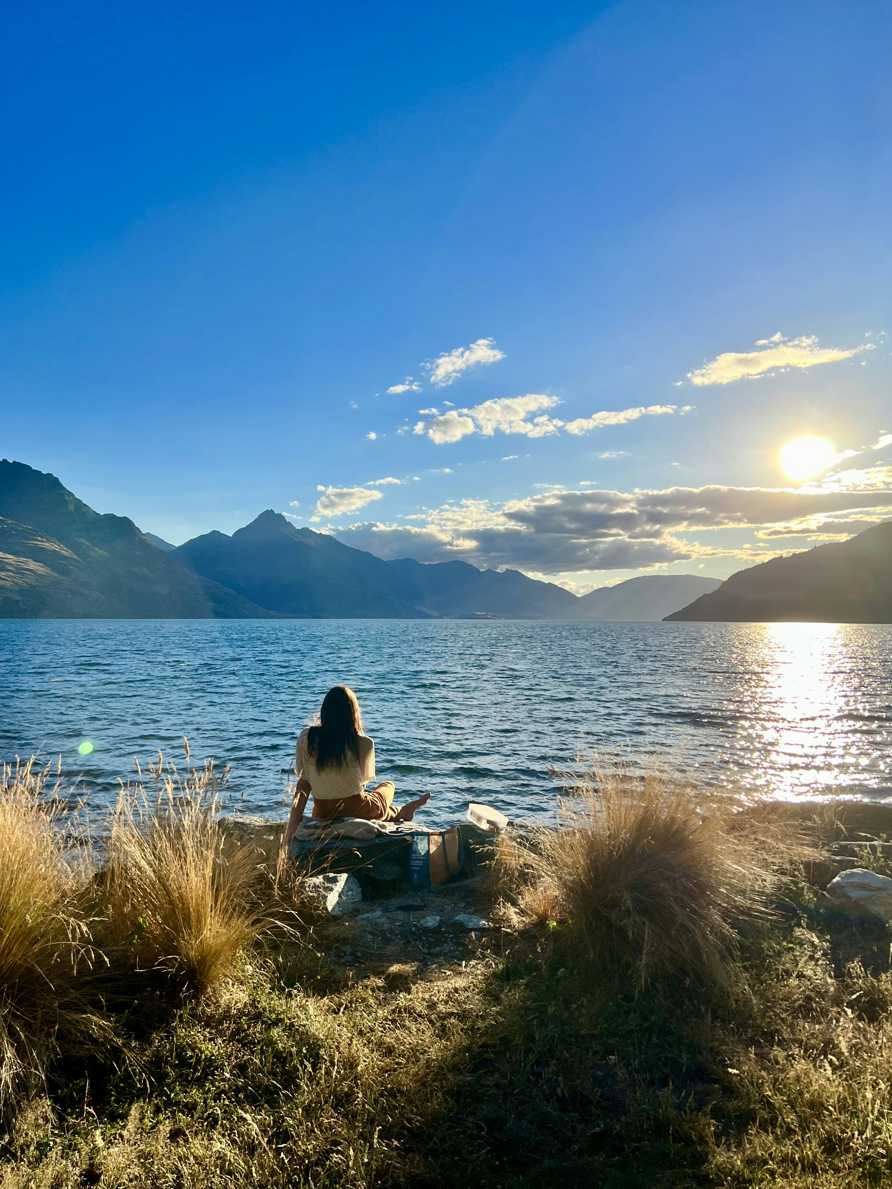 Girl sitting by the lake 