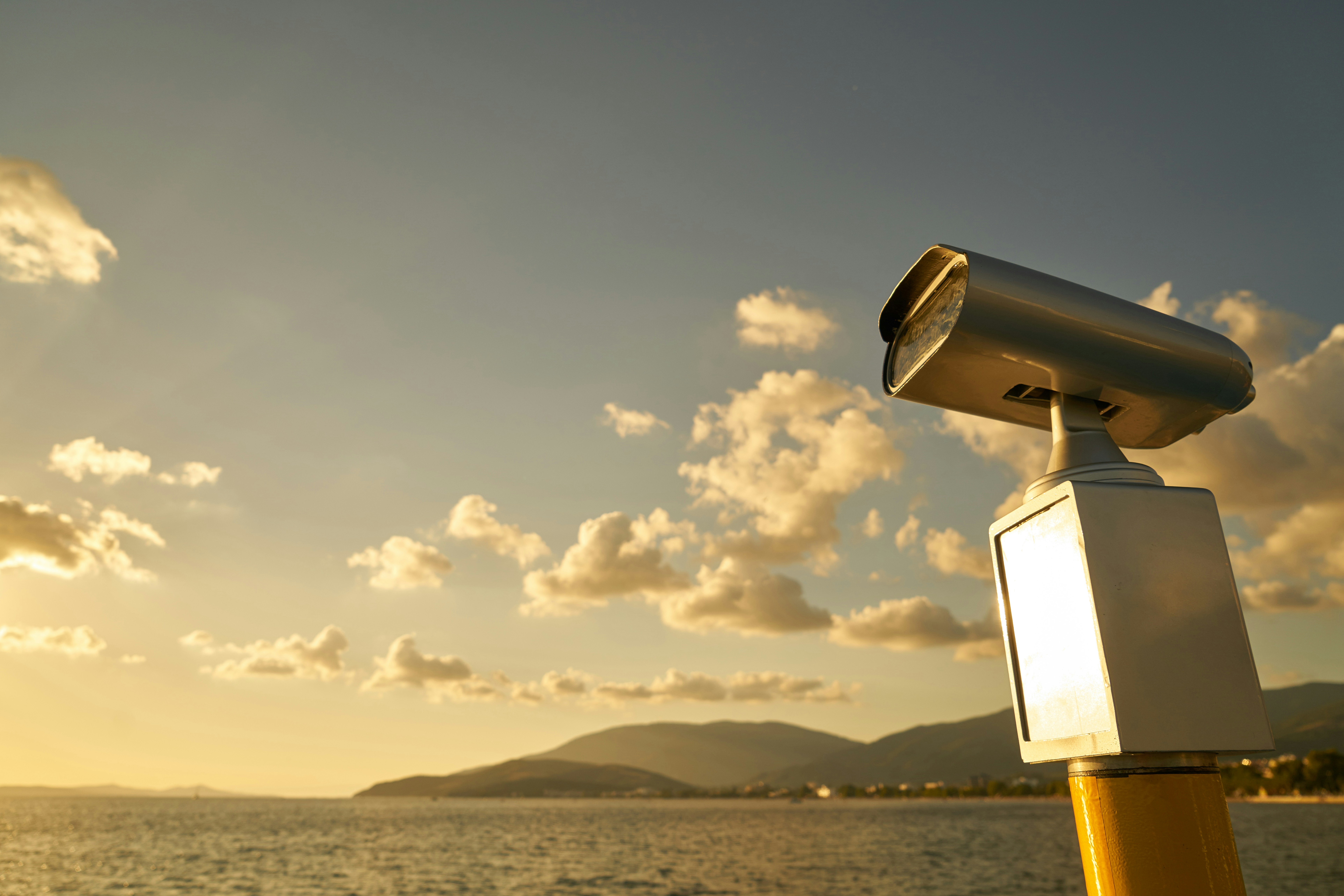 Edge of Day: Seaside Telescope Gazing Over a Quiet Horizon