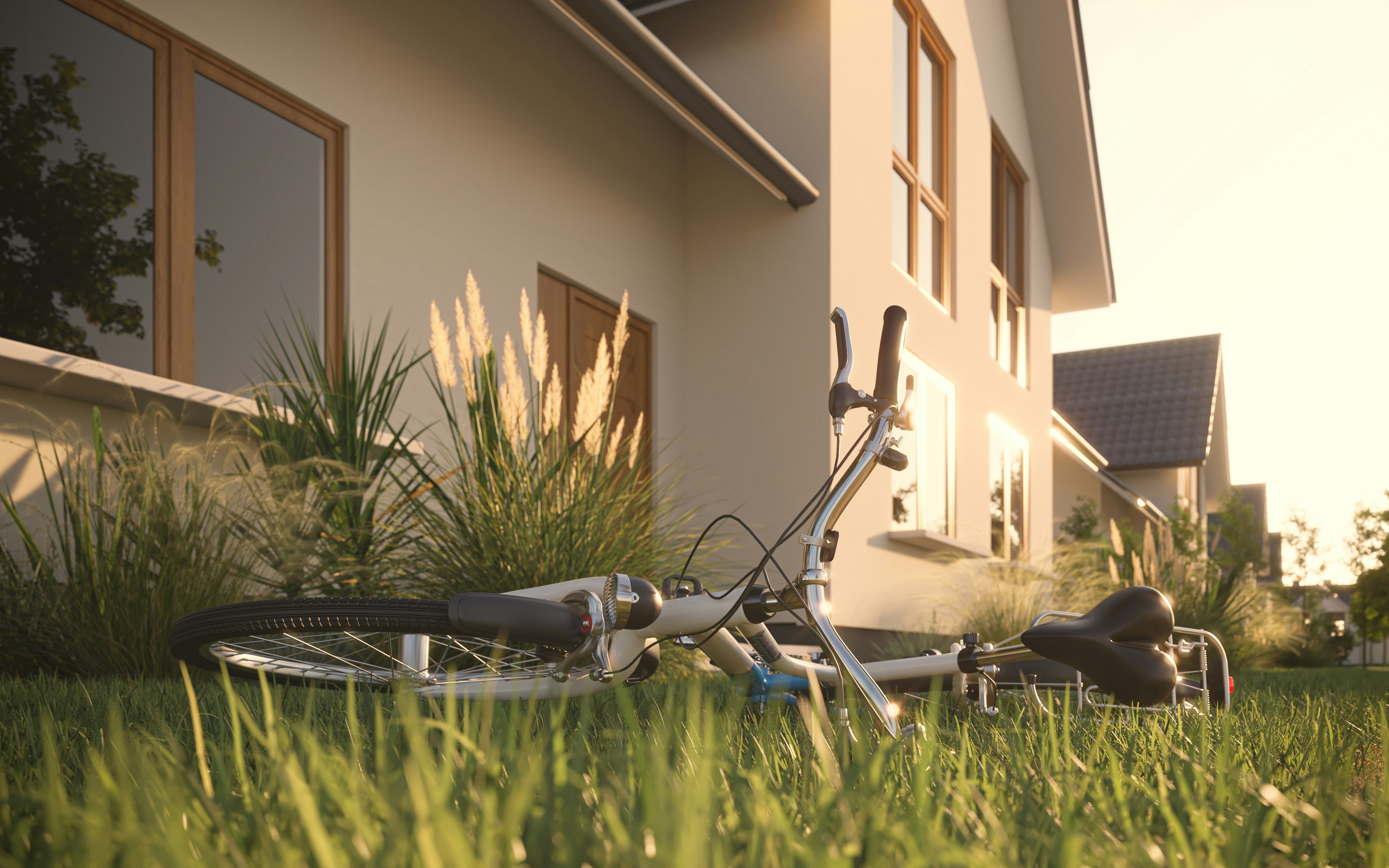 A bicycle laying in the grass in front of a house photo – Free Plant ...