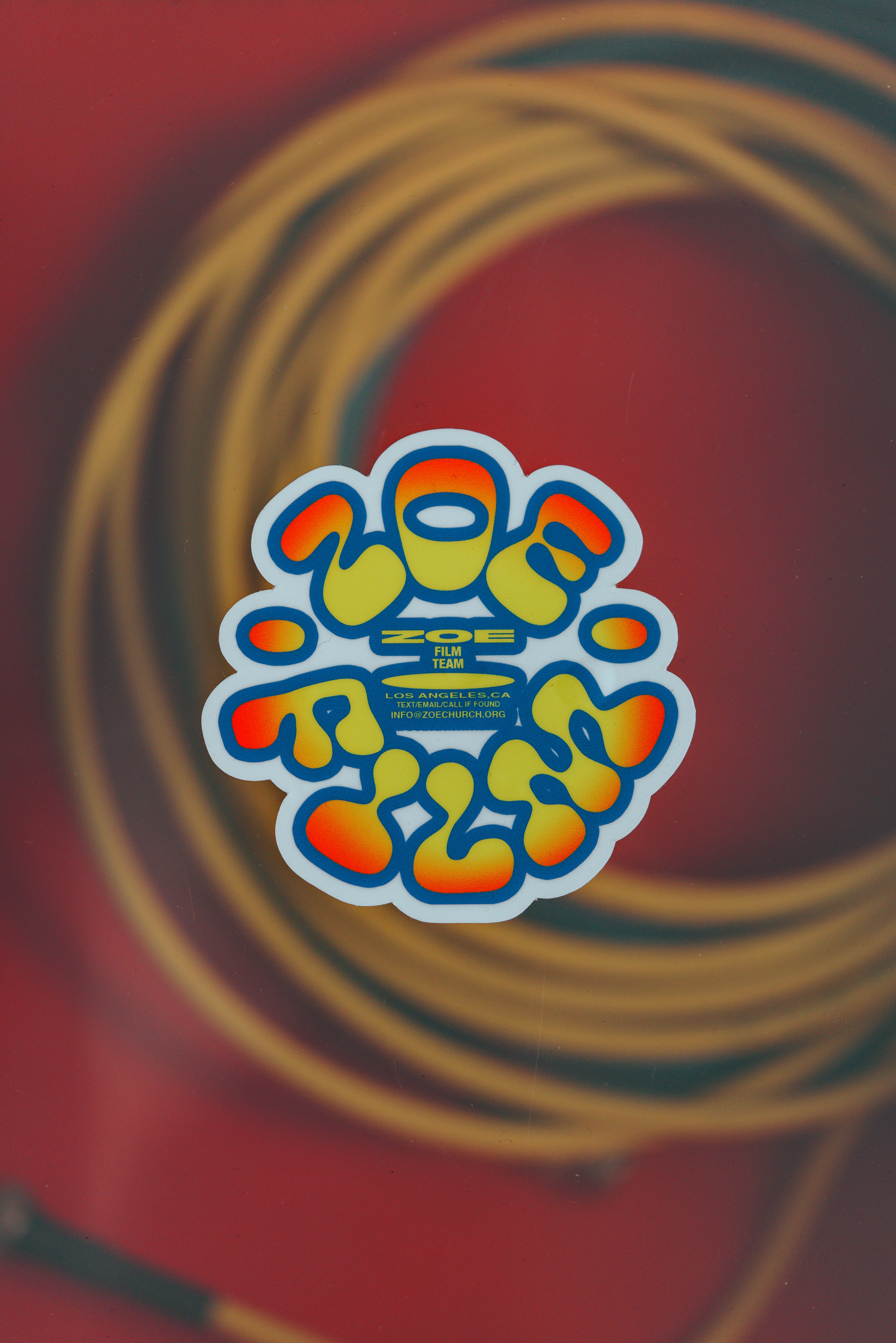 Colorful sticker featuring the text 'ZOE TEAM' against a backdrop of coiled cables. The design is playful and eye-catching.
