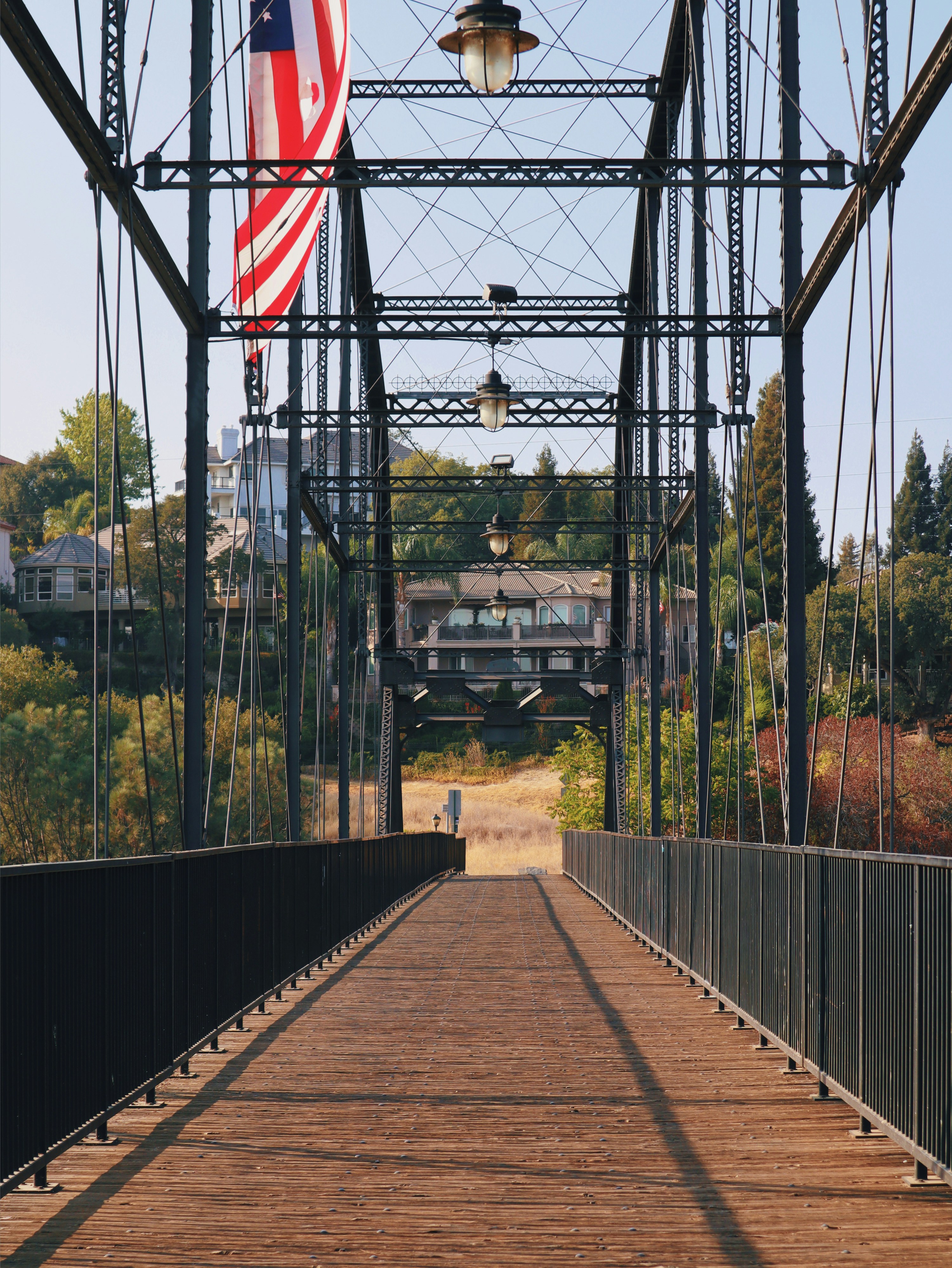 An american flag is hanging on a bridge photo – Free Bridge Image on ...