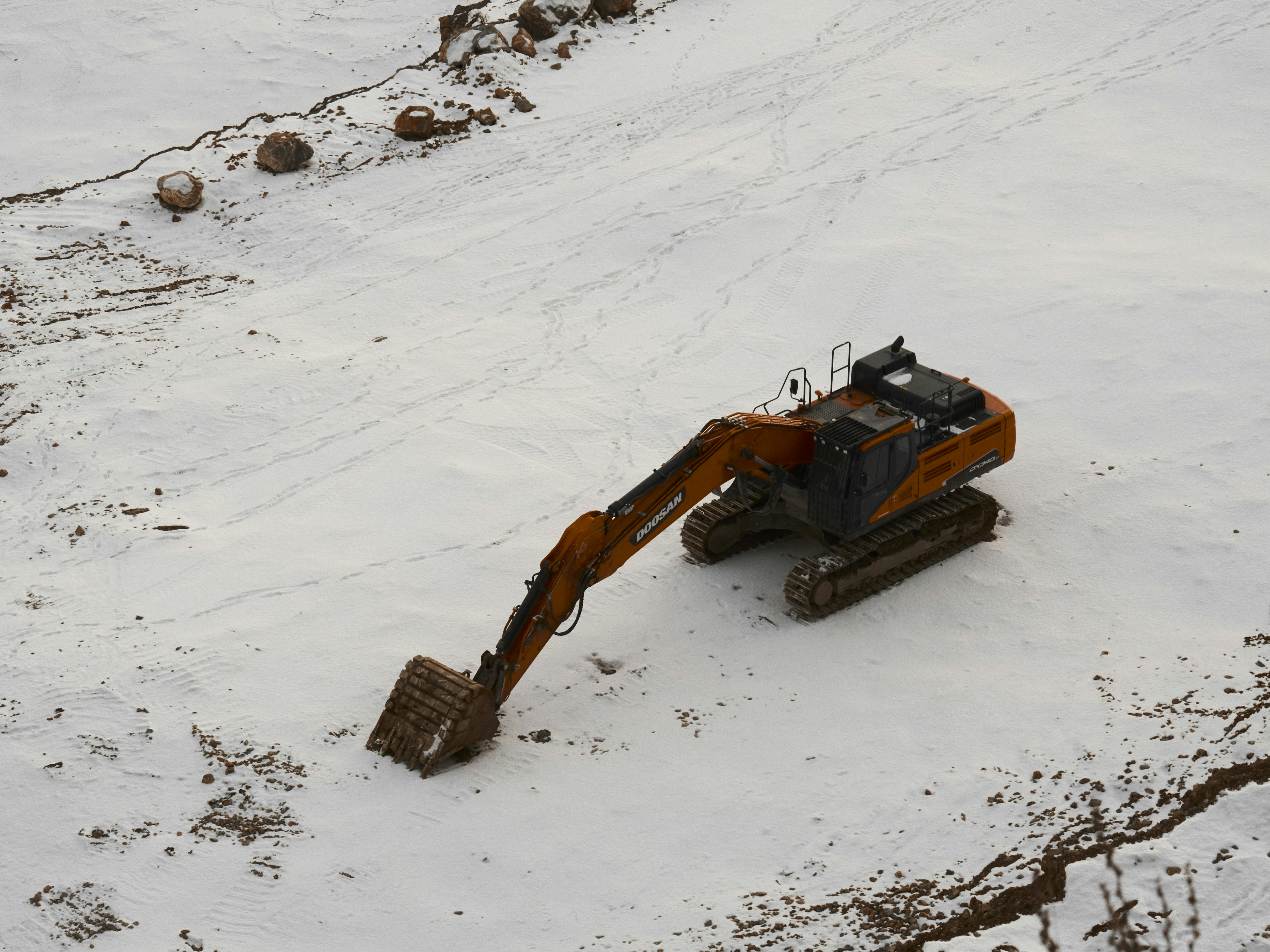A large bulldozer digging through the snow photo – Free Orange ...