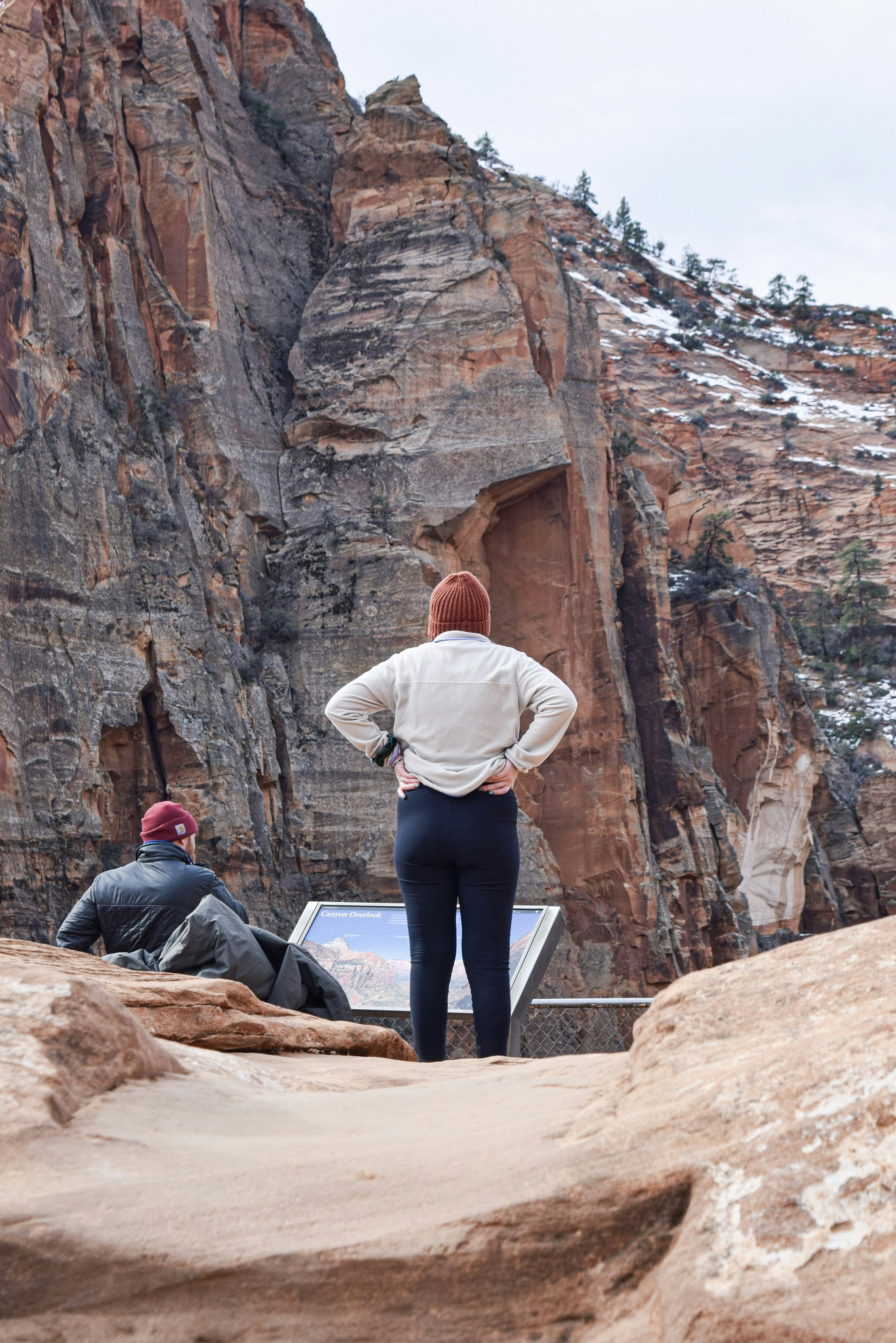 a man and a woman standing in front of a mountain