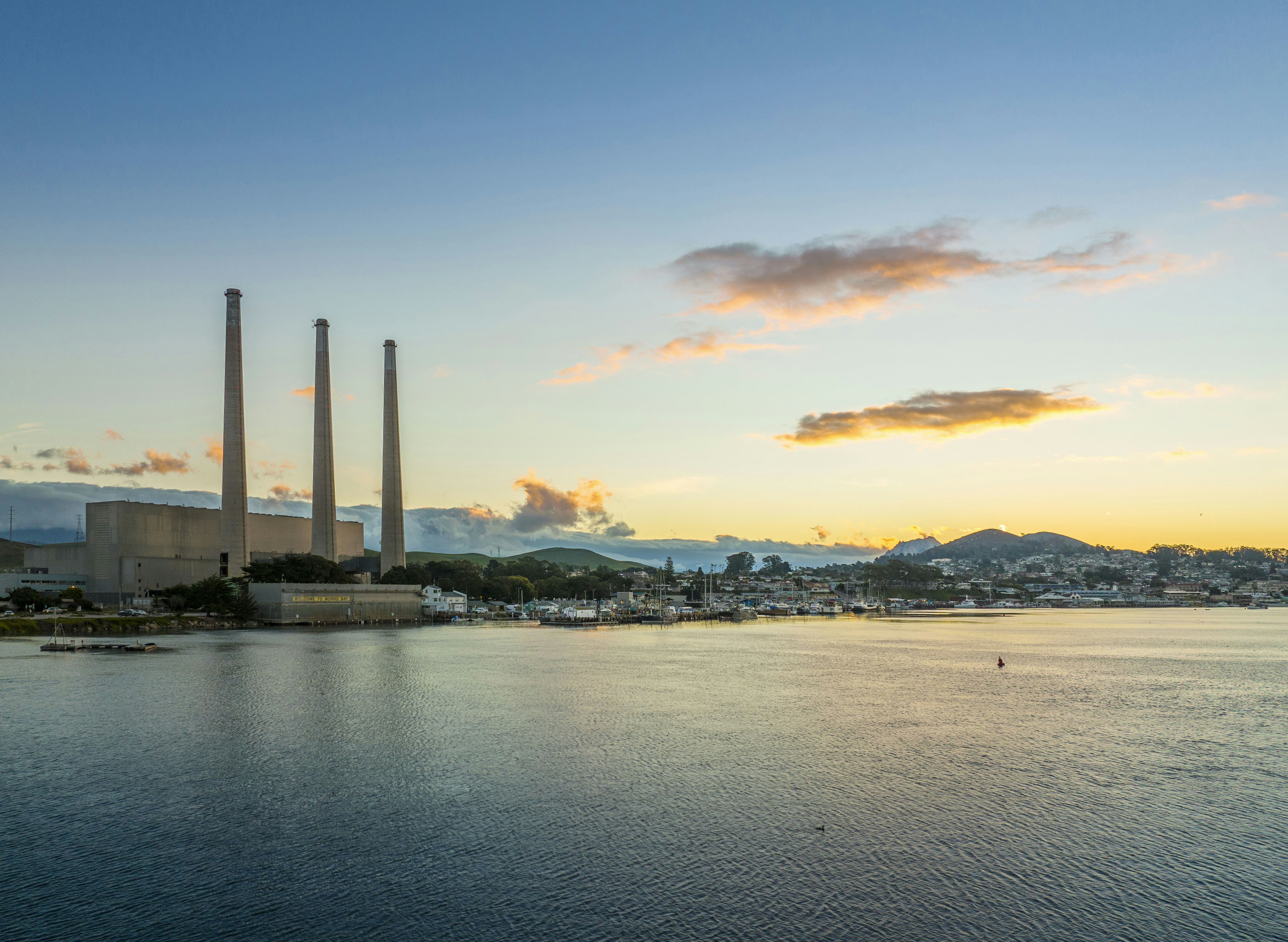 A view of a large power plant from across the water photo – Free ...