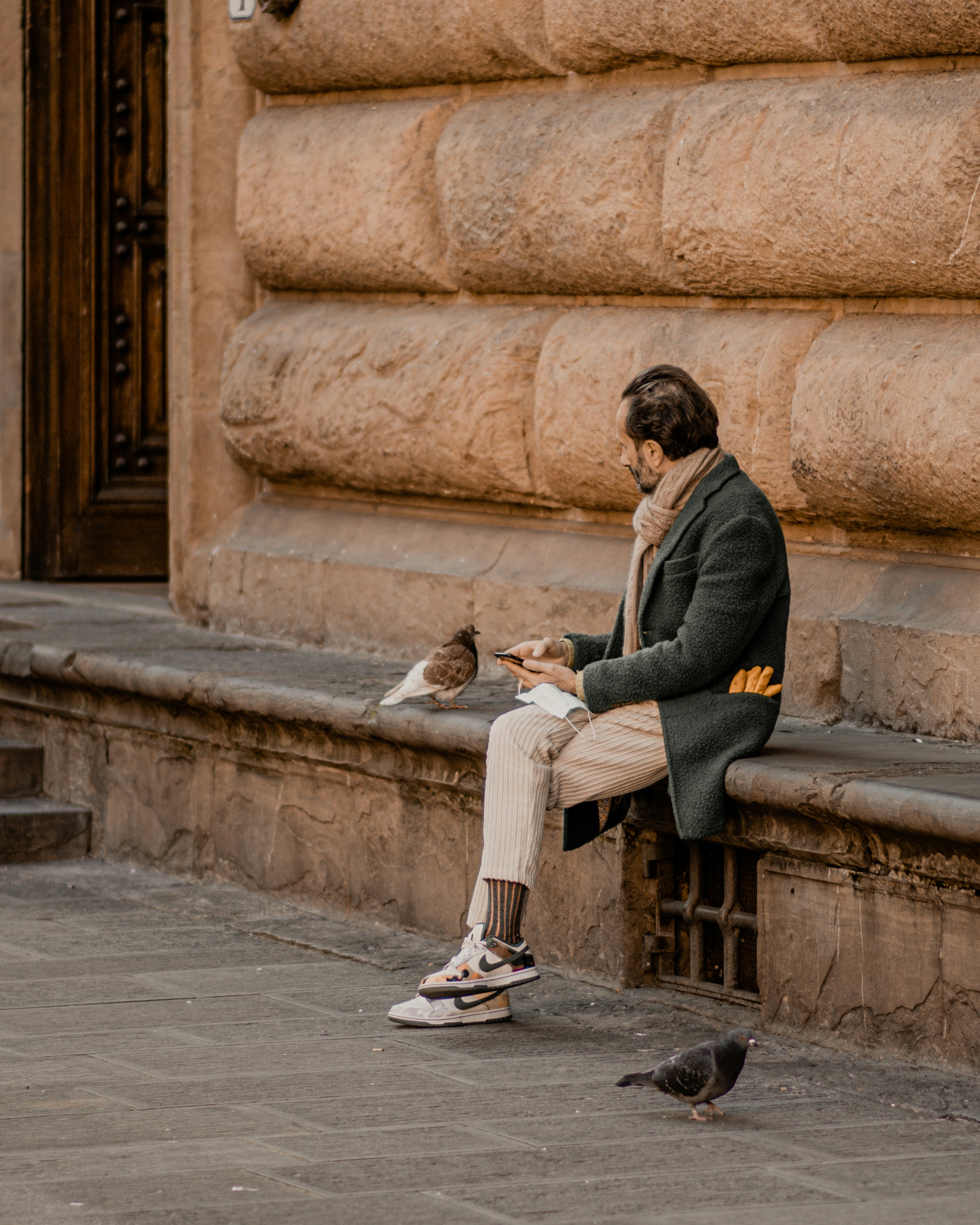 Street Portrait in Amber Light: A Man and His Pigeon