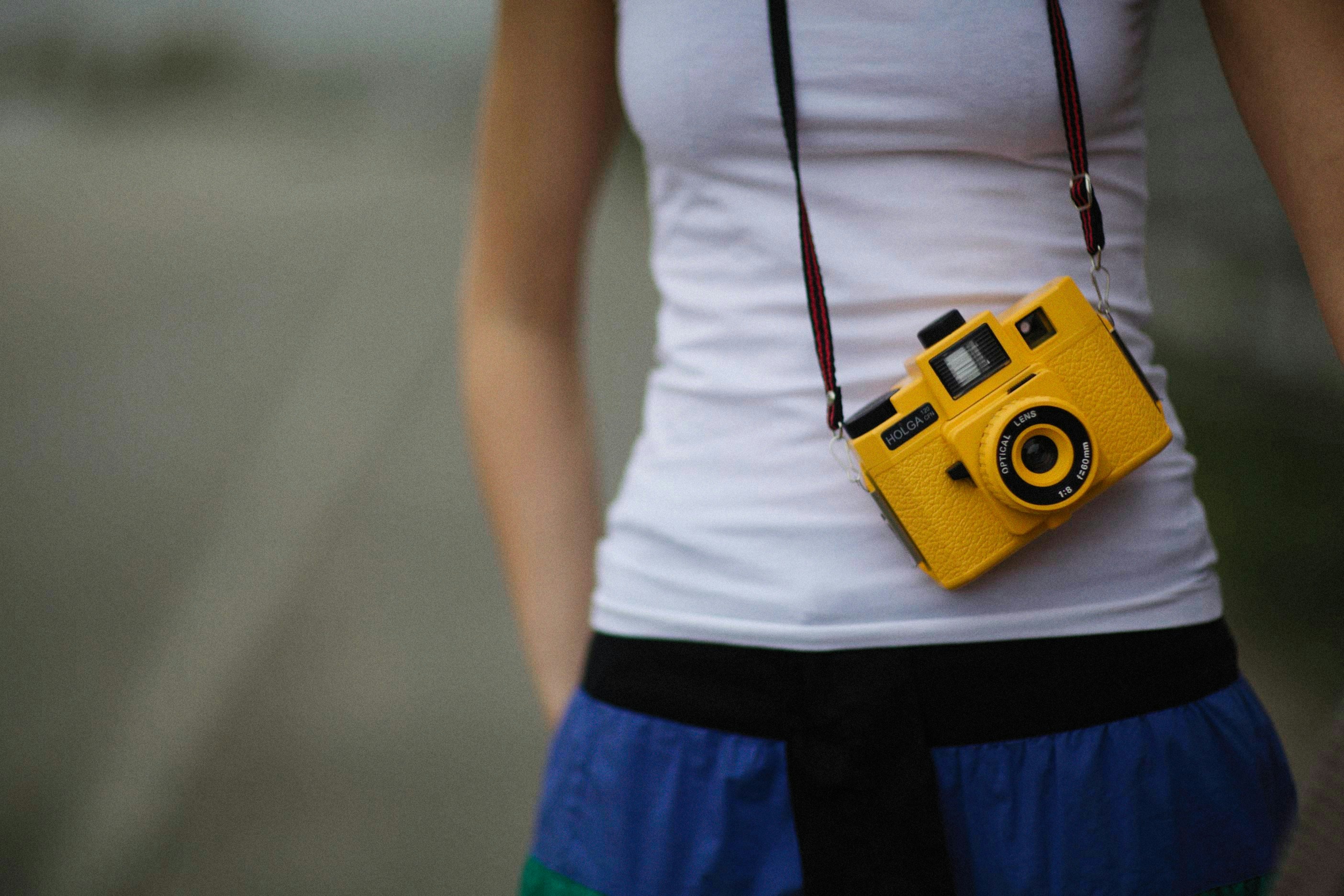 Yellow Accessory, Quiet Street: A Bold Camera Centered in a Minimal Portrait