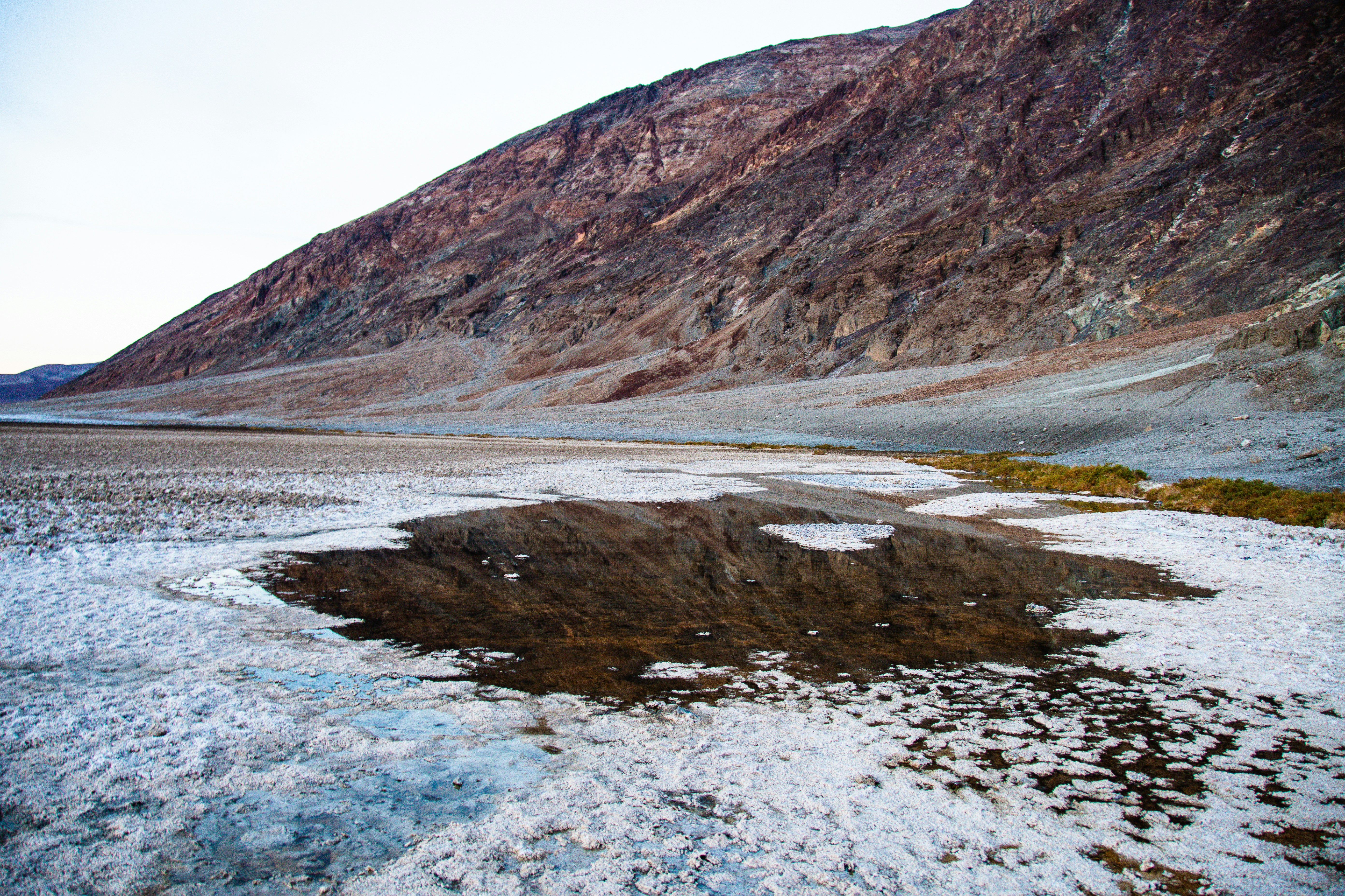 A mountain with a small patch of ice on the ground photo – Free Grey ...