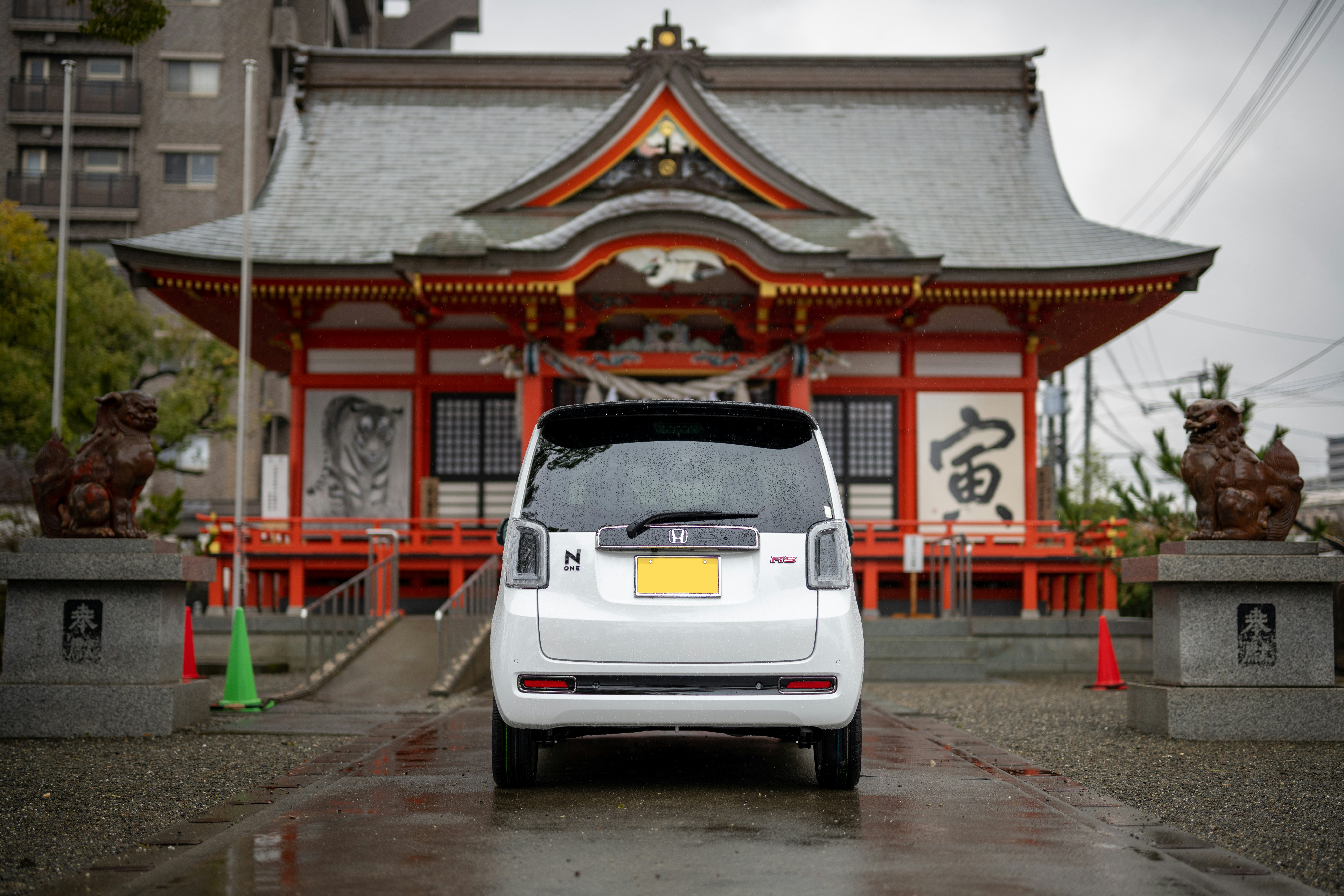 a small white car parked in front of a building