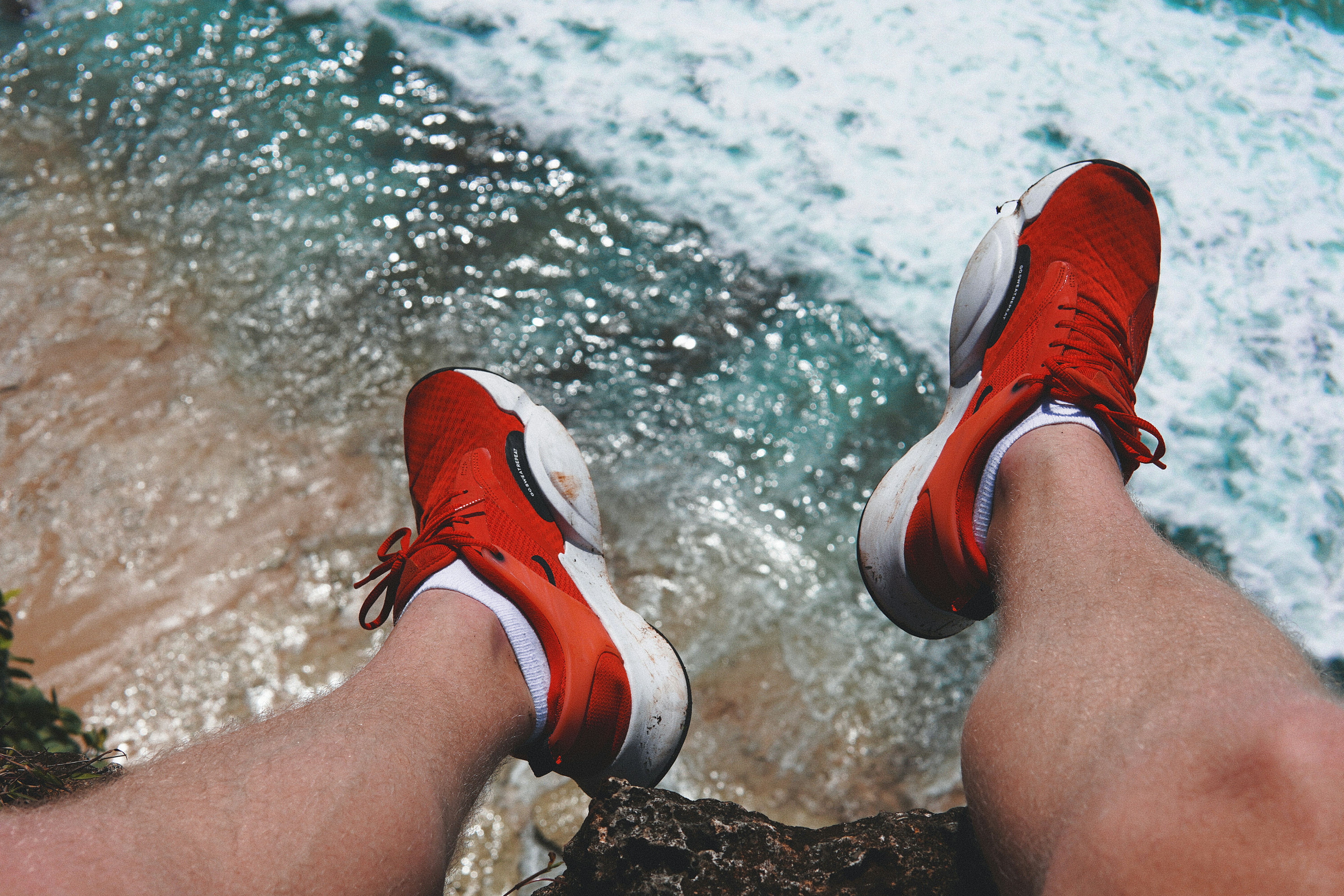 Over the Edge: Crimson Kicks Over a Turquoise Abyss