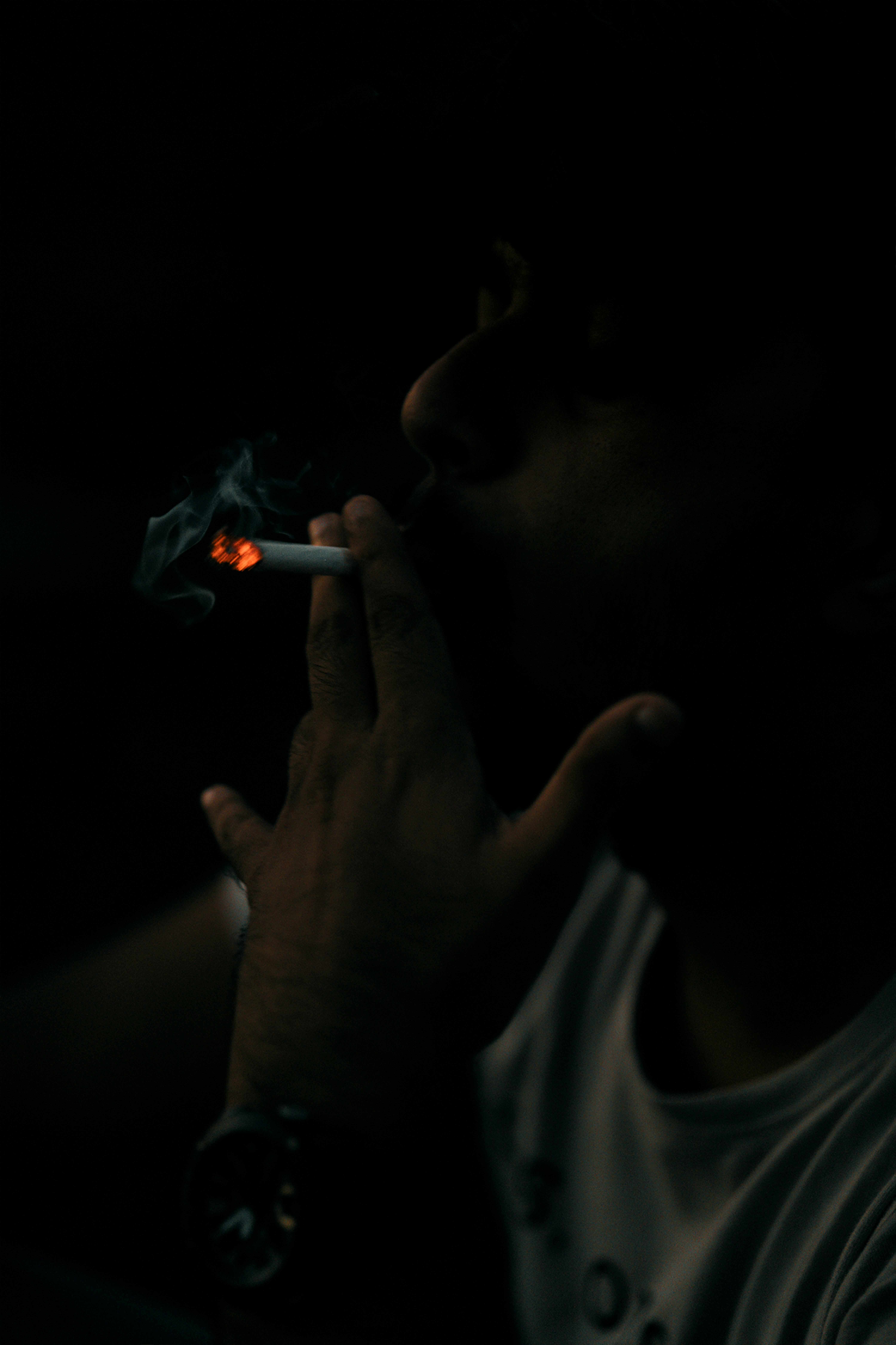 A man smoking a cigarette in the dark photo – Free Human Image on Unsplash